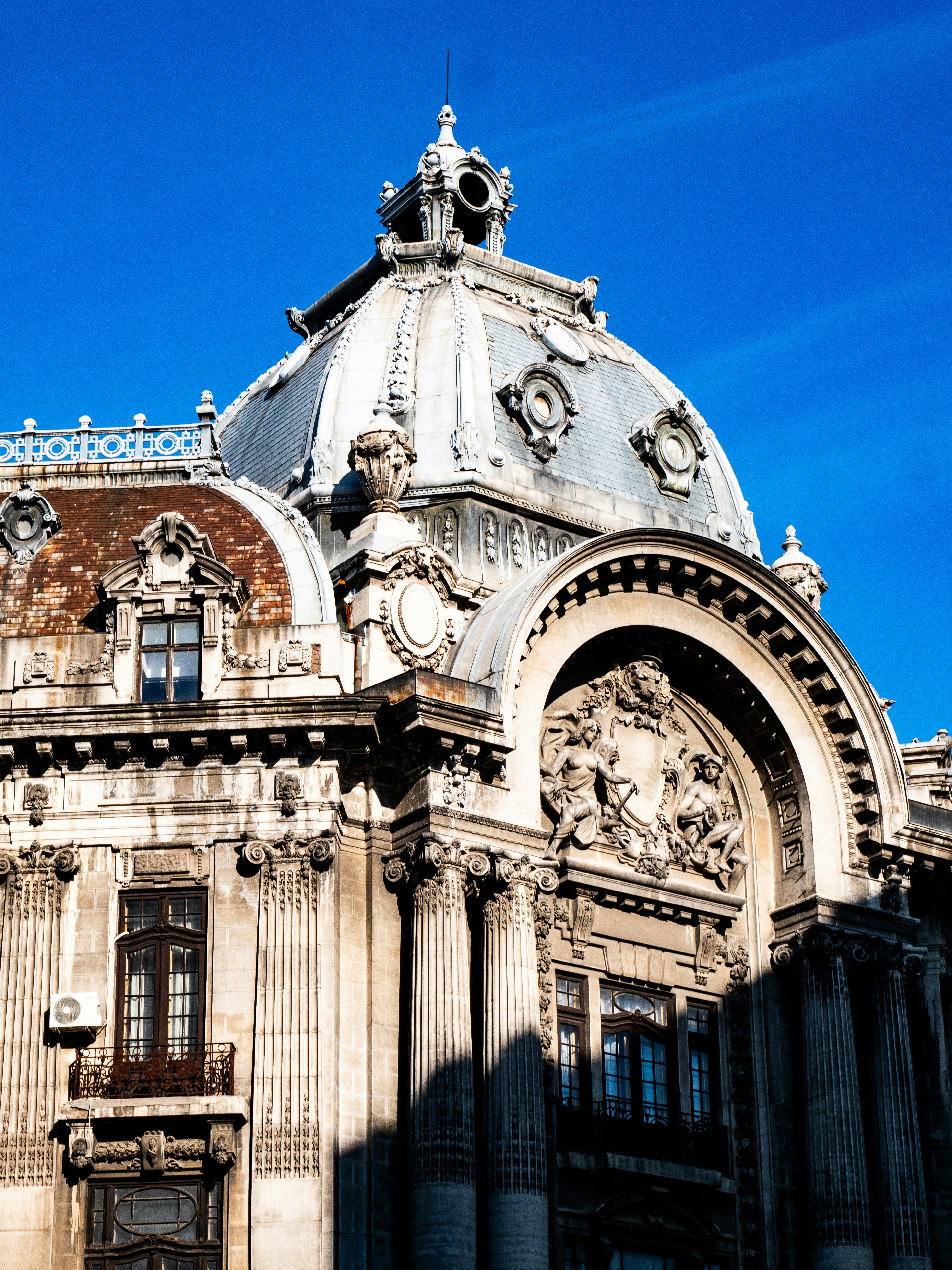 A large building with a clock on the top of it photo – Free Bucharest ...