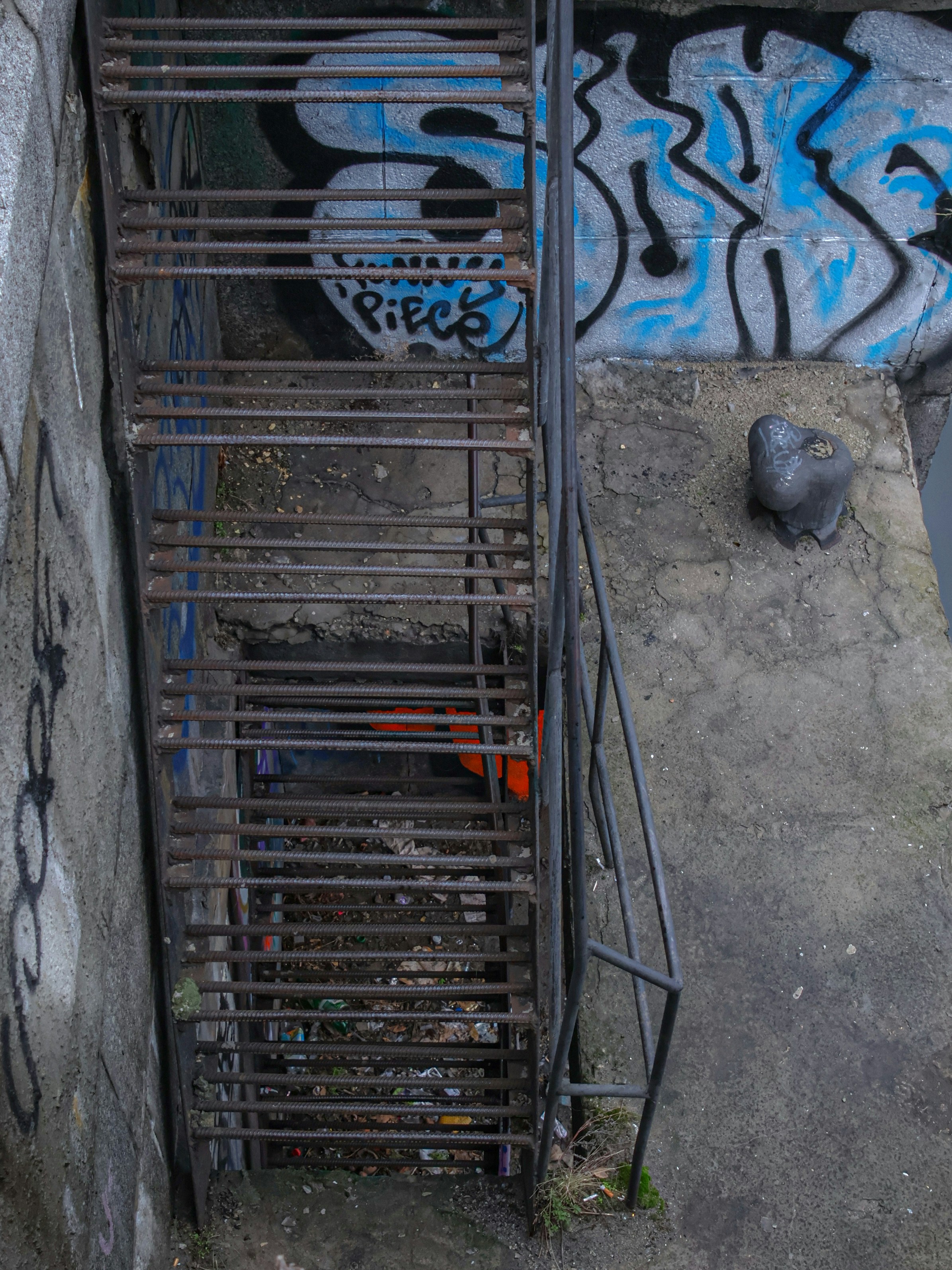 Rusted Stairwell, Graffiti Walls: Descending Between Concrete and Color