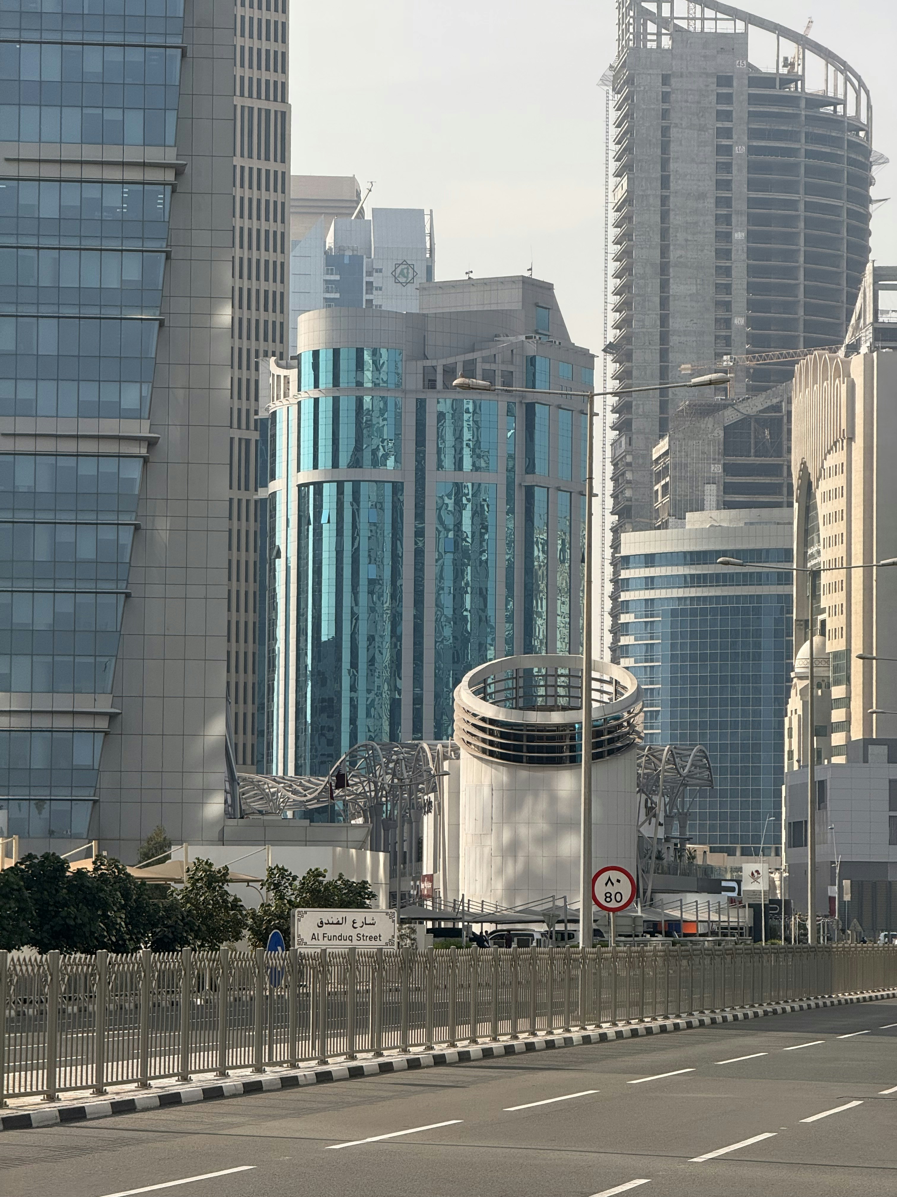 Azure Facades Rise Over a Moving Boulevard