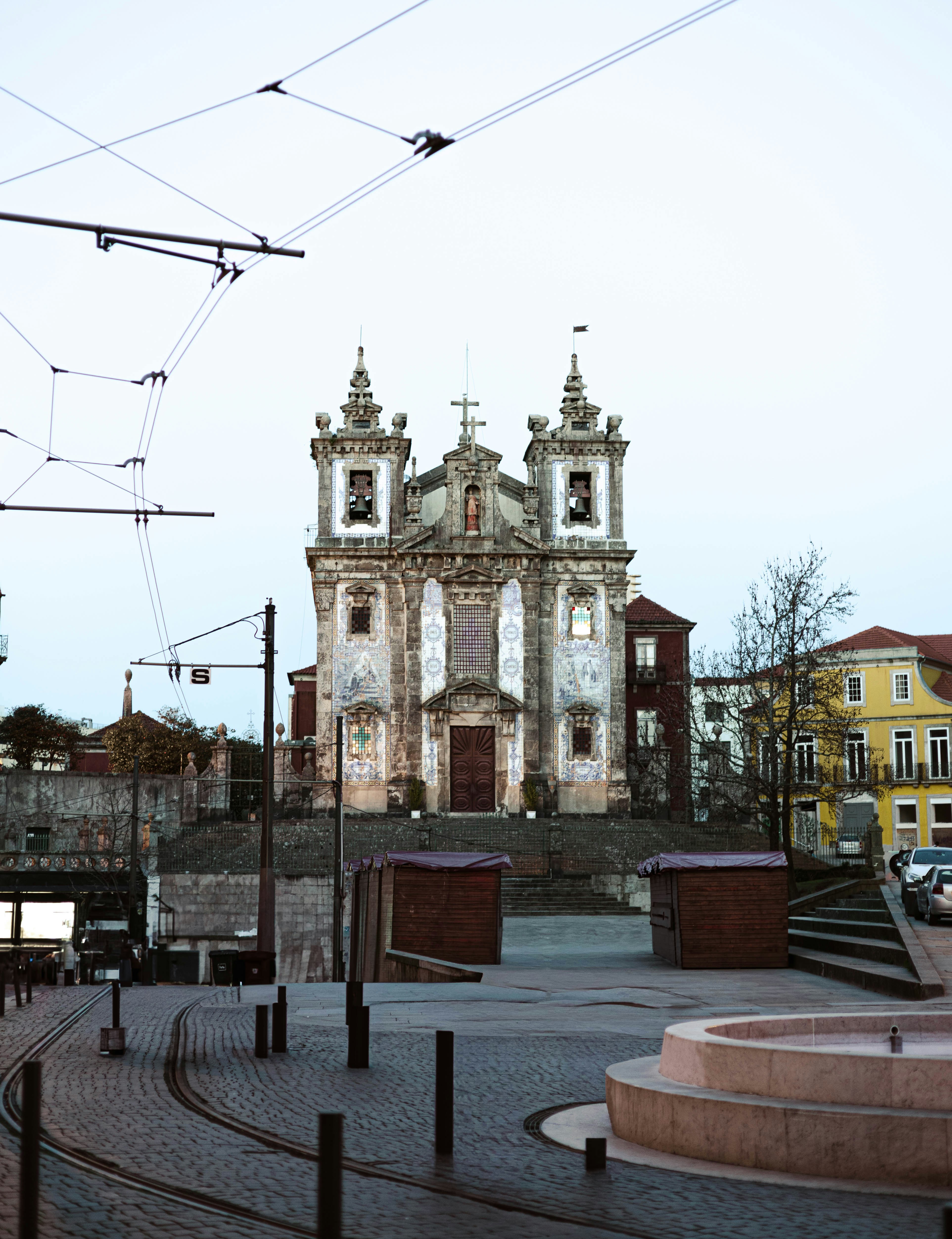 Weathered Baroque Facade Framed by Tram Wires in a Quiet City Square