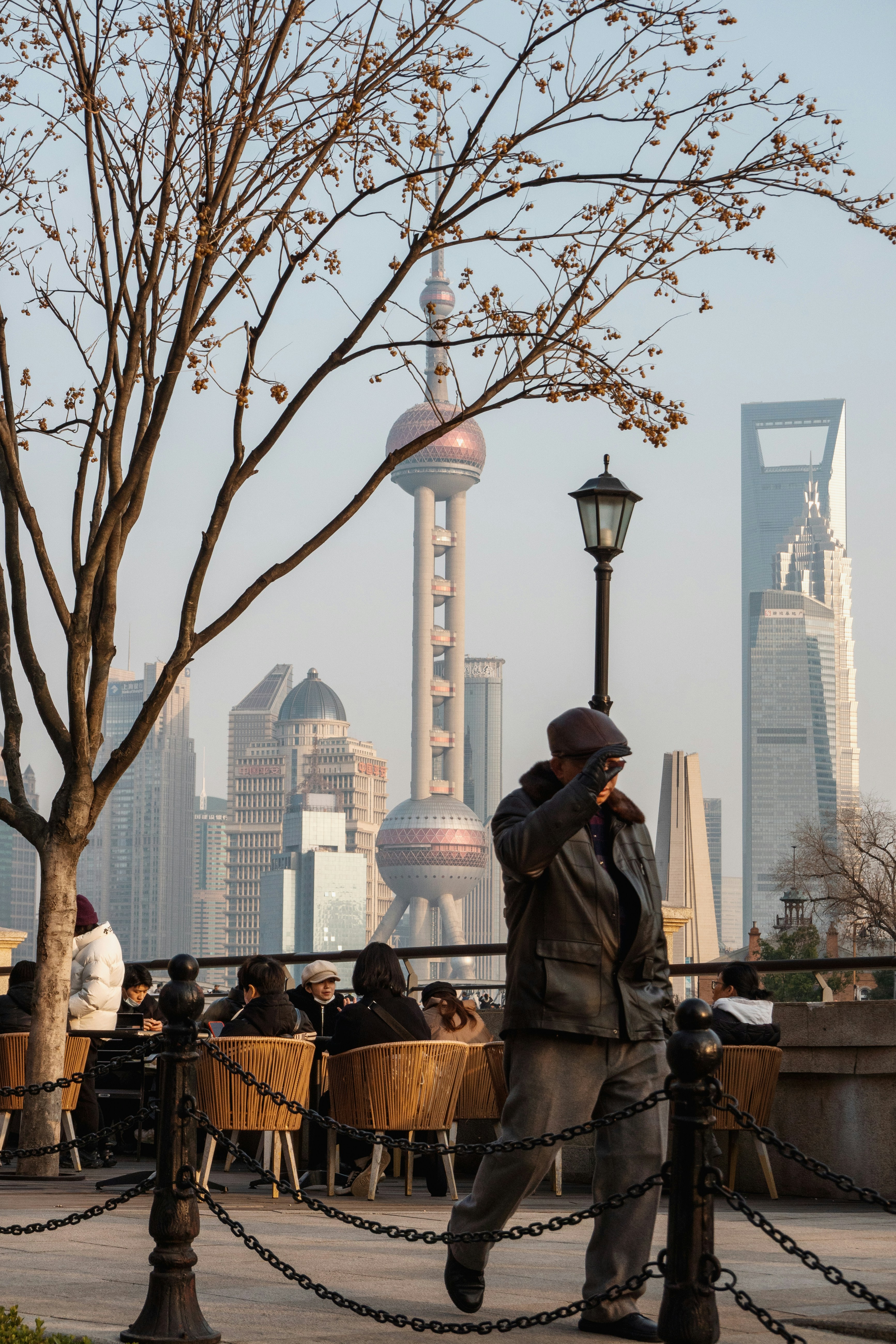 Shadowed Pedestrian at the Bund Framed by Shanghai’s Pearl Tower
