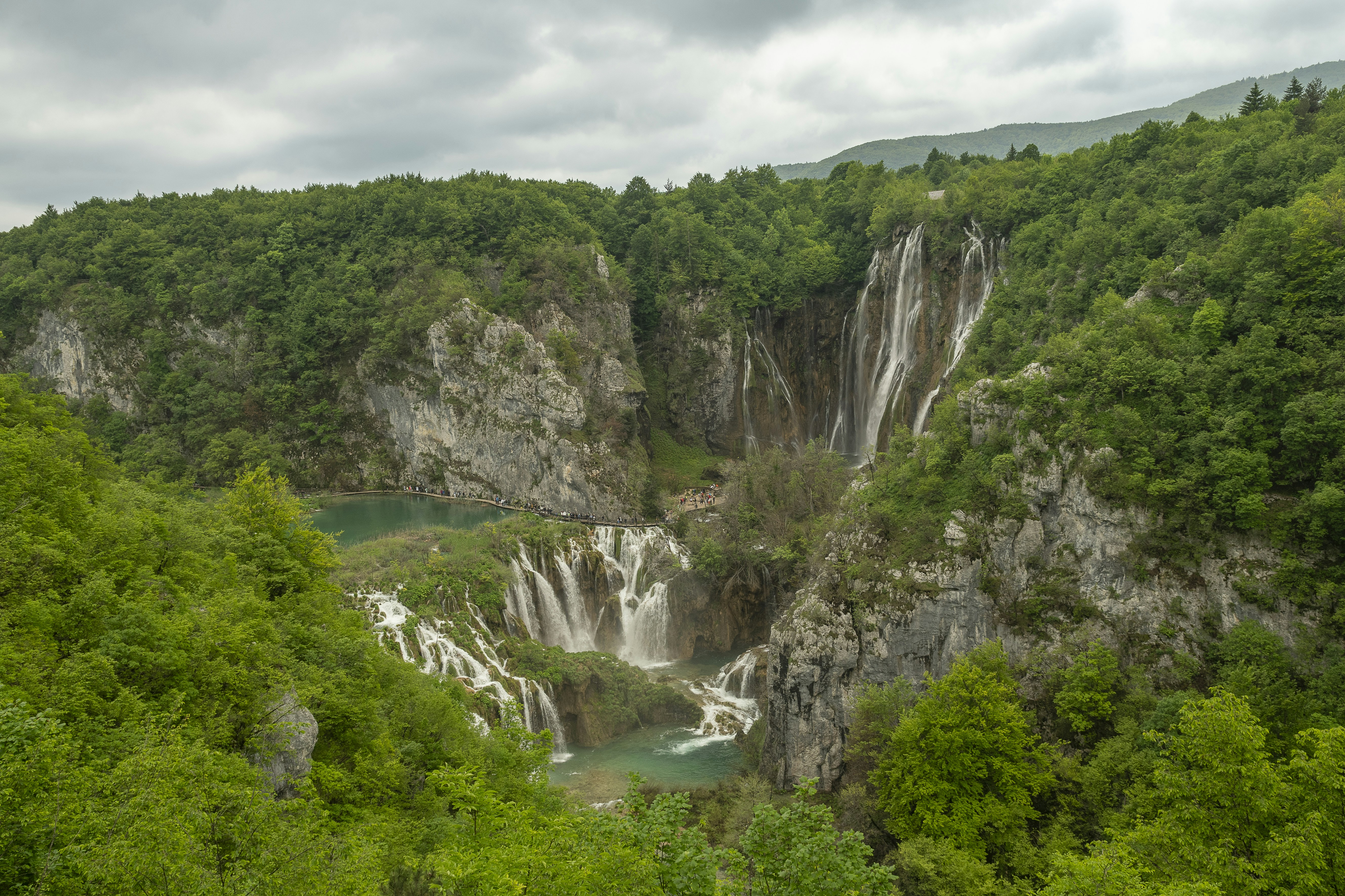 A view of a waterfall in the middle of a forest photo – Free Forest ...
