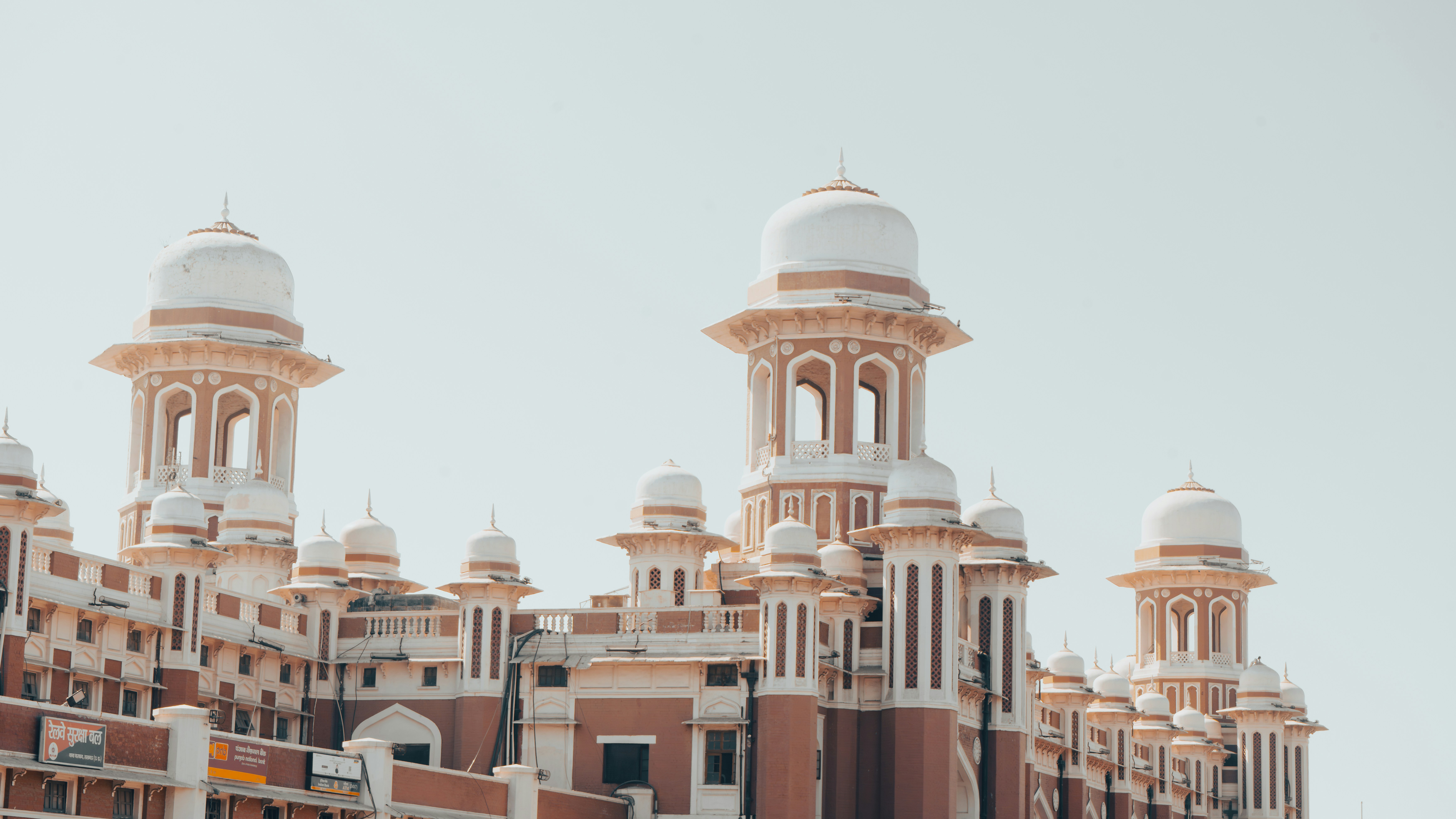 Ornate building with multiple domes and intricate details under a clear sky.
