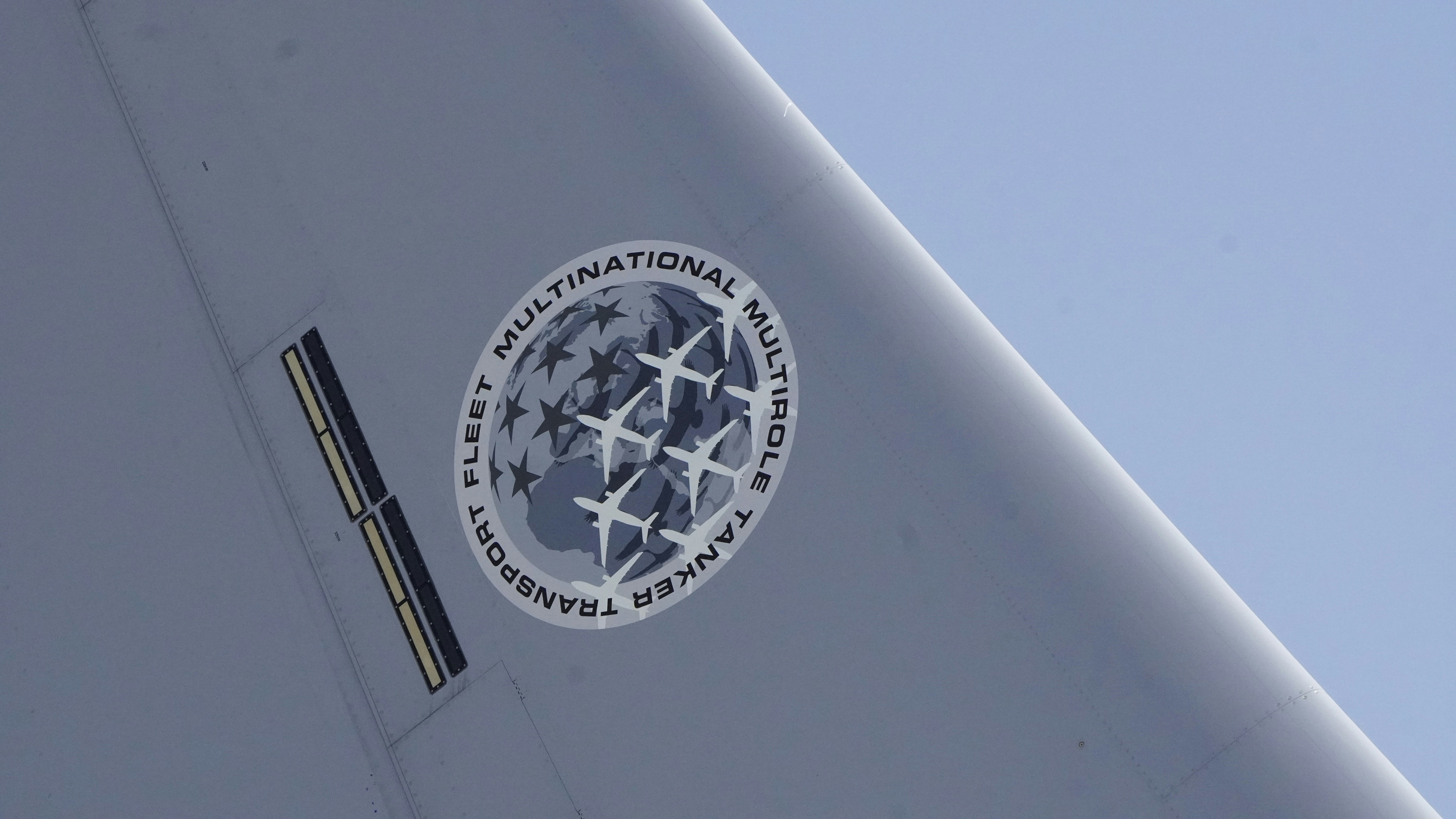 Emblem in Flight: A Circular Squadron Patch on White Fuselage