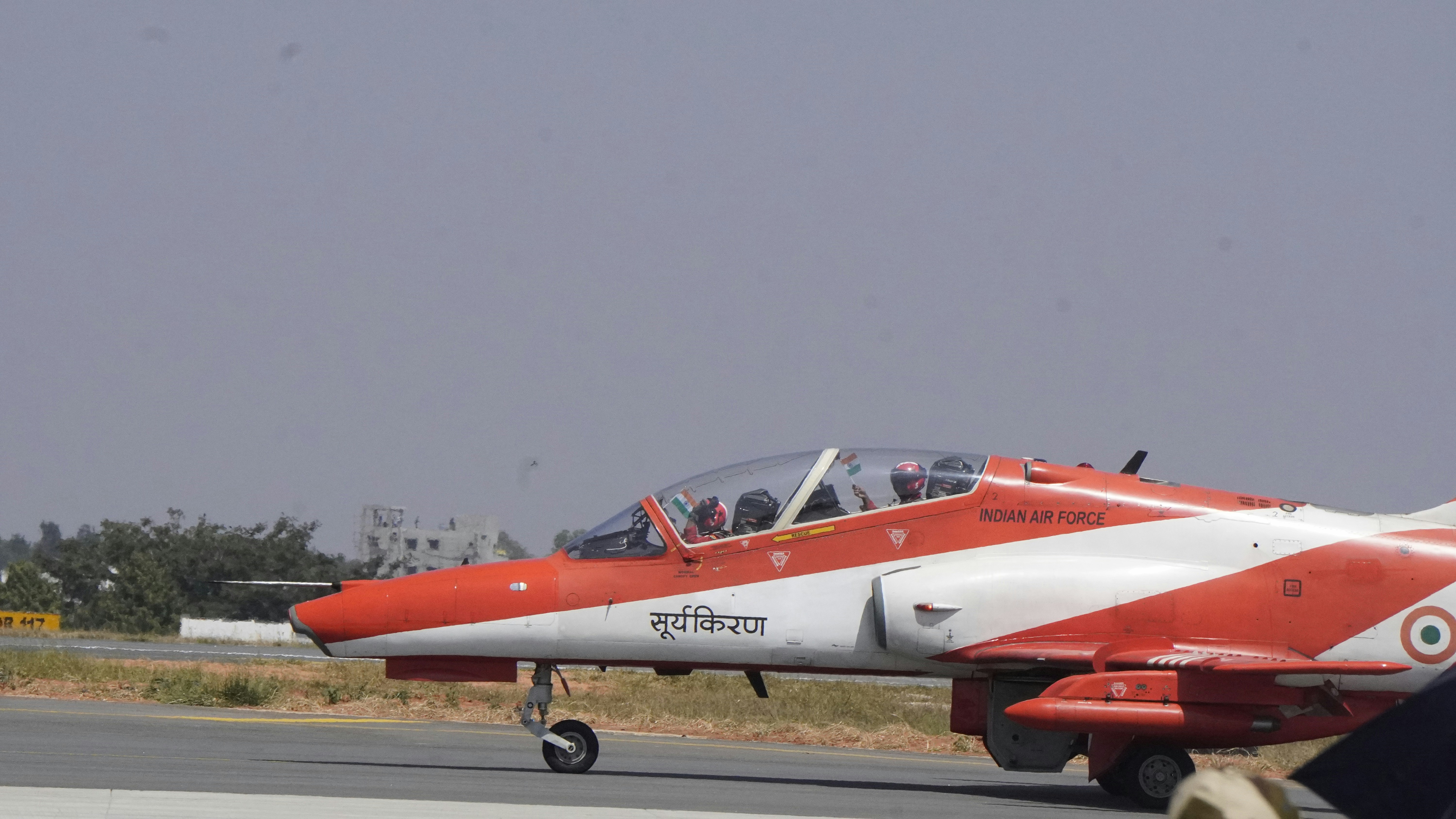 A red and white jet sitting on top of an airport runway photo – Free ...