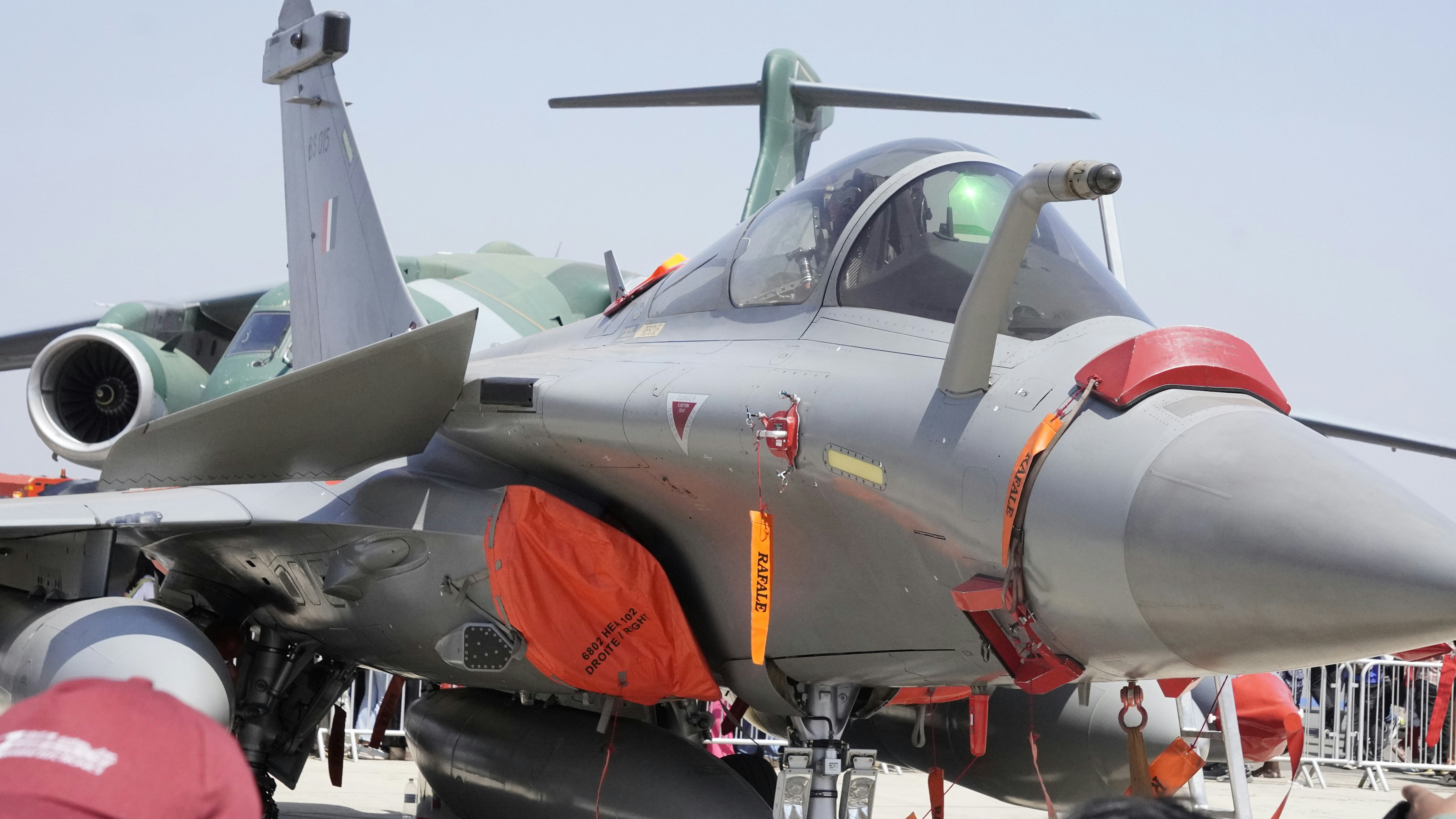 A fighter jet sitting on top of an airport tarmac photo – Free ...