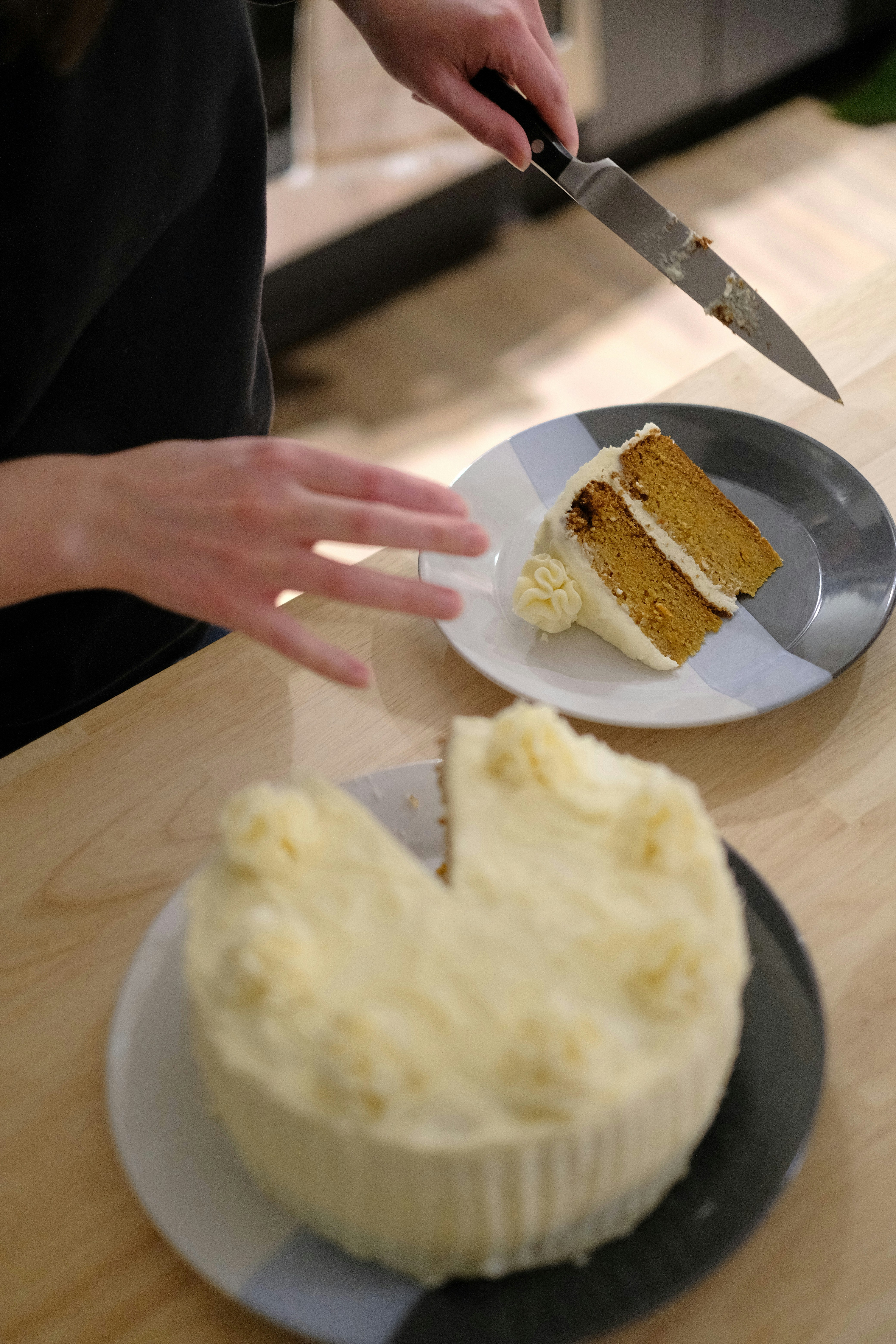 A person cutting a piece of cake with a knife photo – Free Food Image ...
