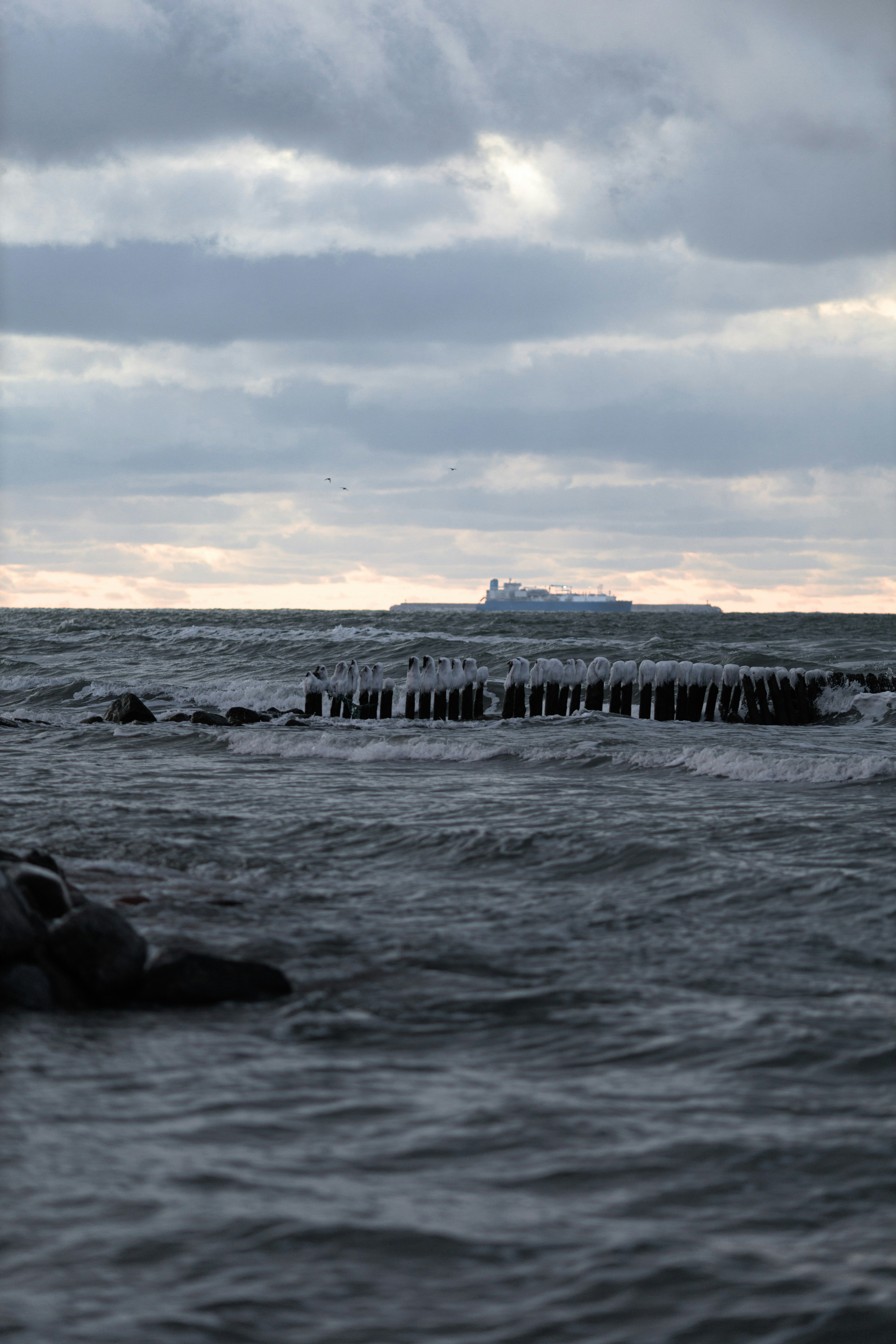 Muted Horizon: Ship Crossing a Chilly Evening Sea