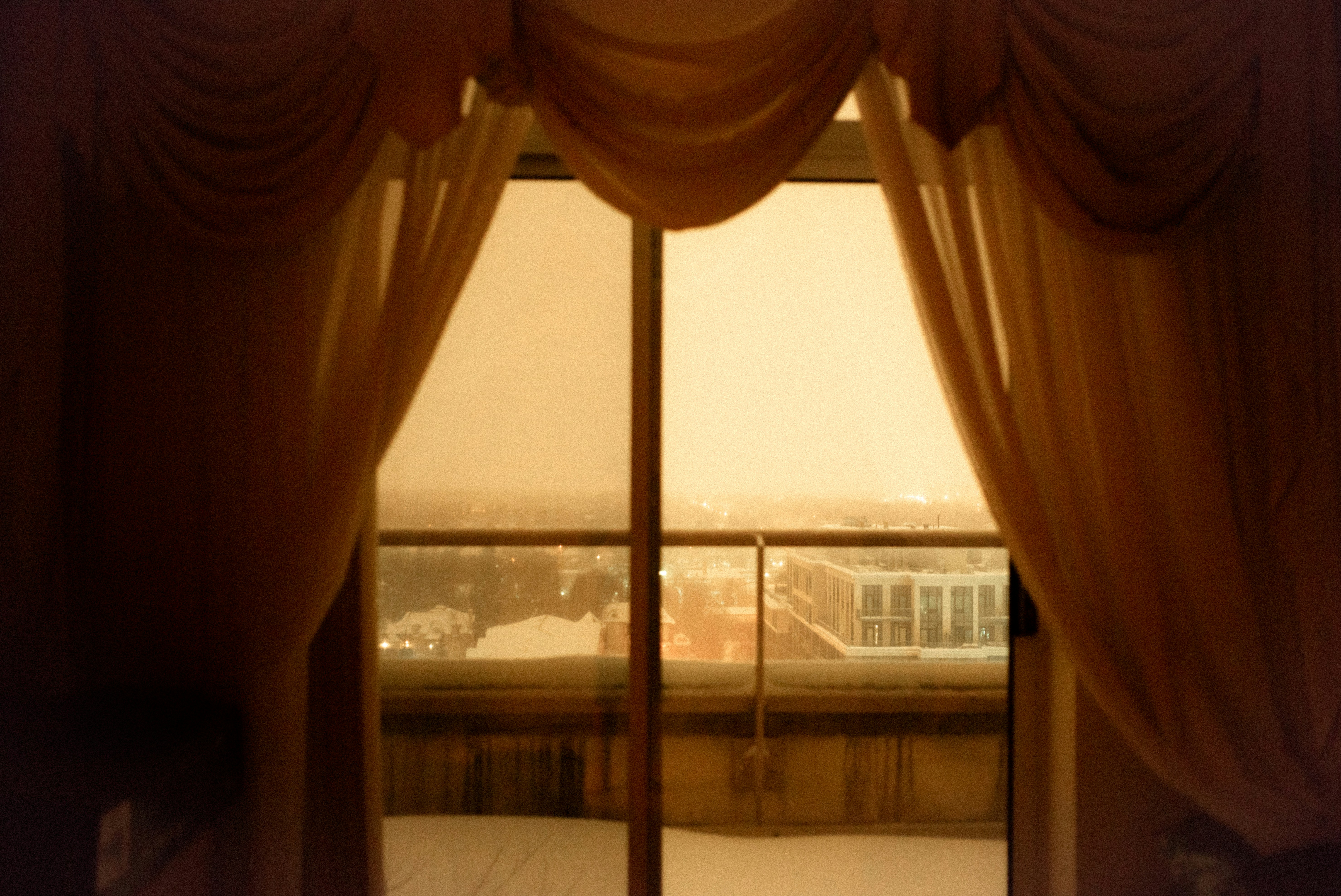 Golden Haze Beyond Velvet Curtains