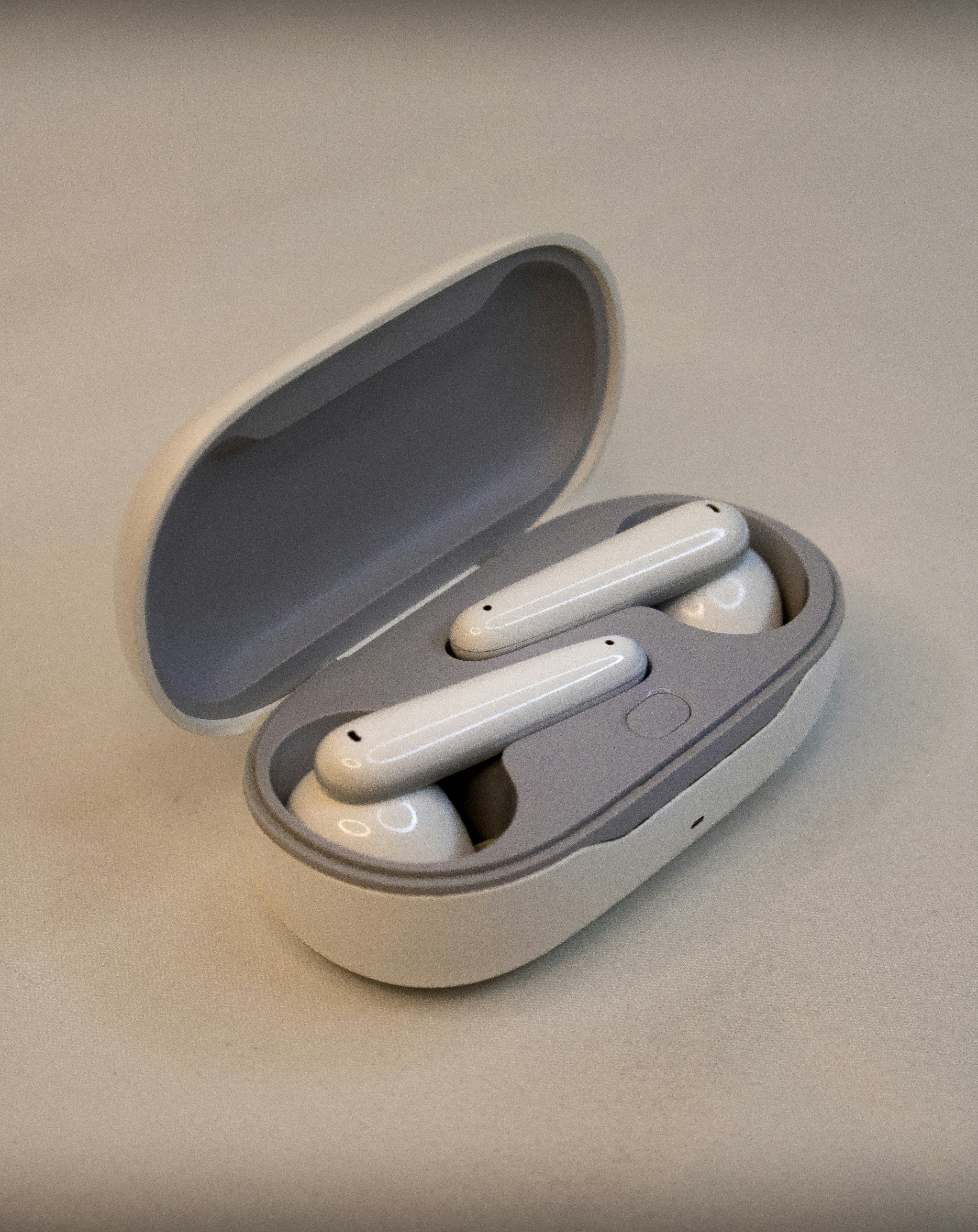 A pair of ear buds in a case on a table photo – Free Medellín Image on ...