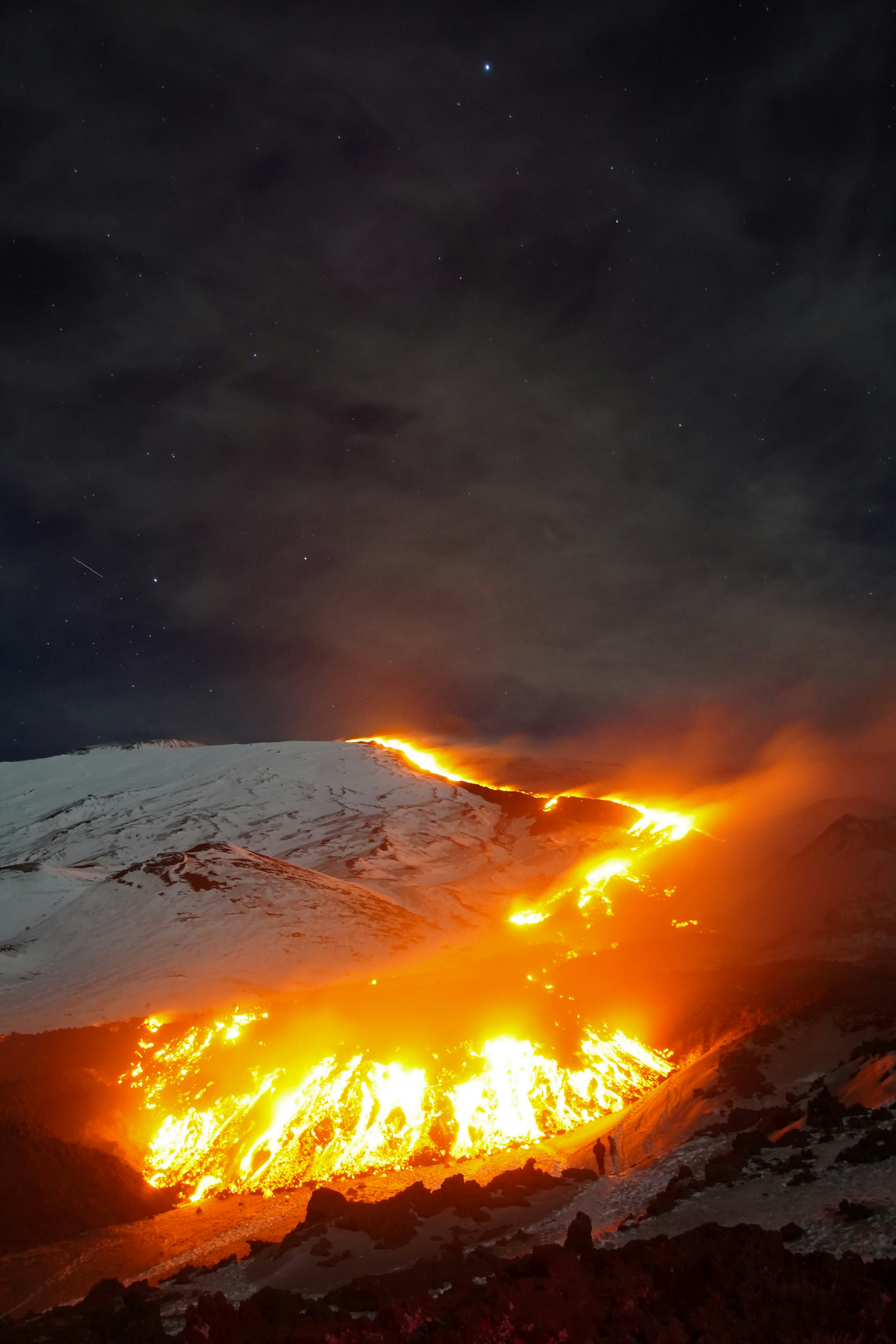 A mountain covered in fire and lava under a night sky photo – Free Fire ...