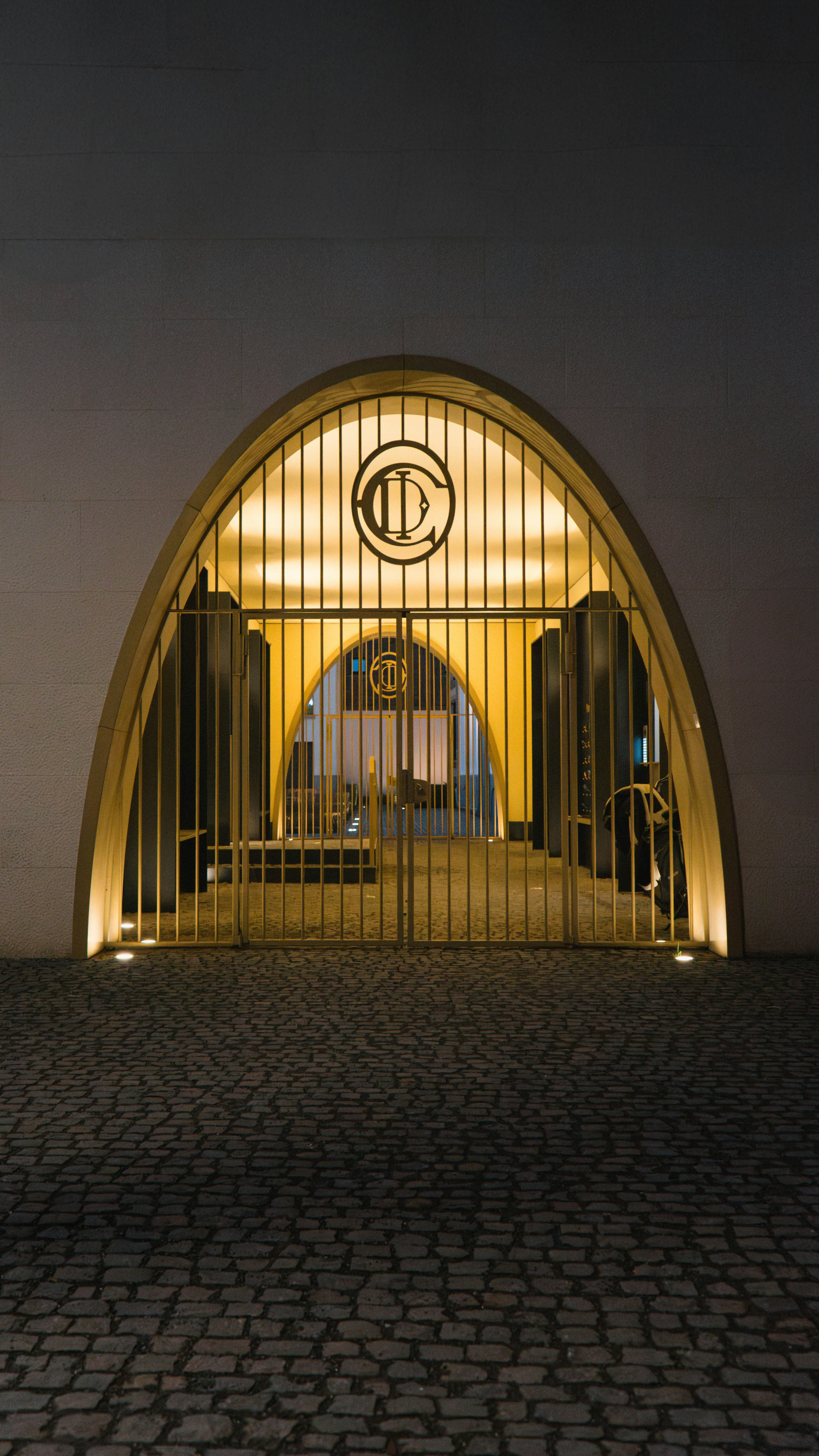 Golden Arch Gate at Night: Threshold to a Lantern-lit Interior