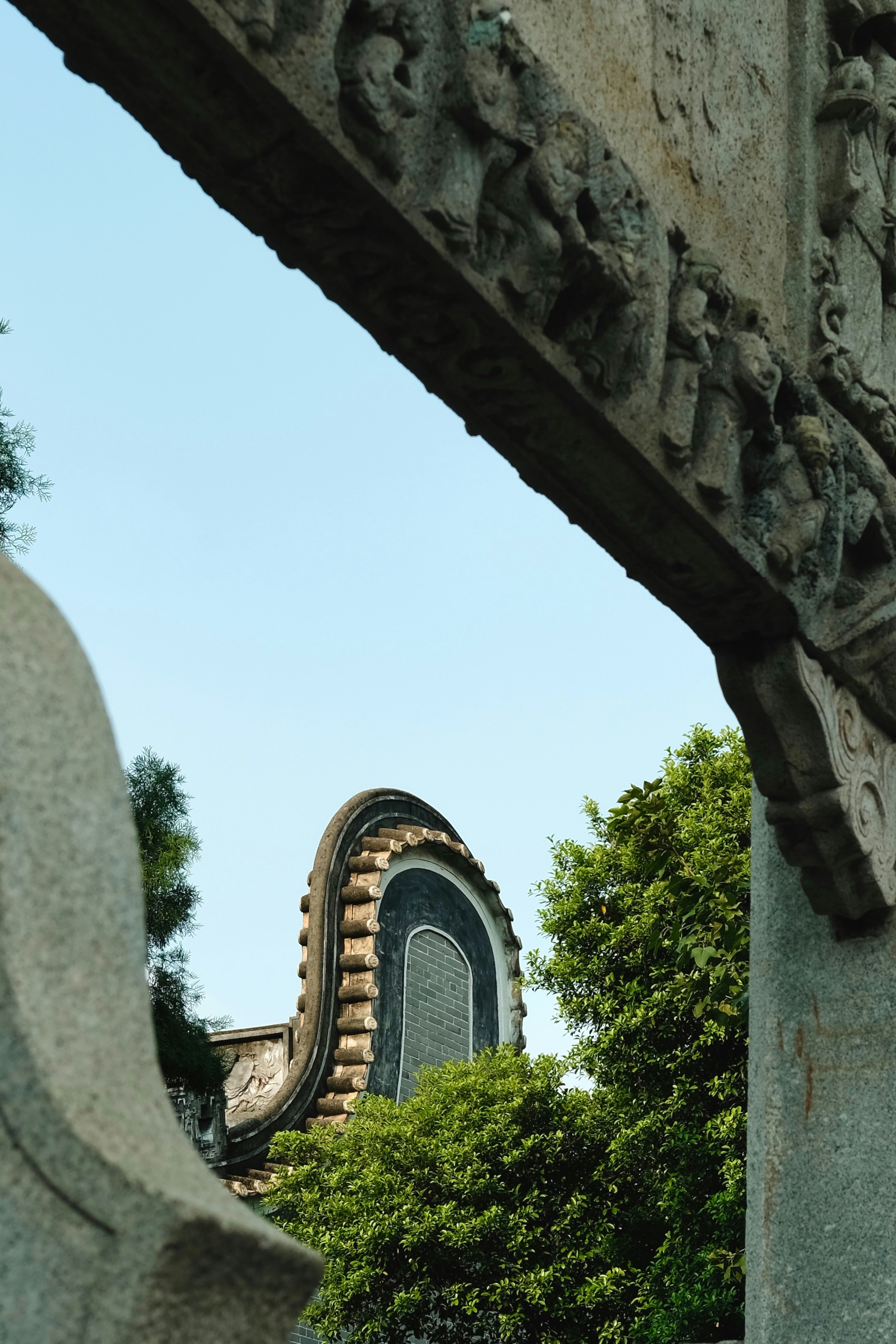 Archway of Sculpted Shadows Framing a Curved Roof Pavilion