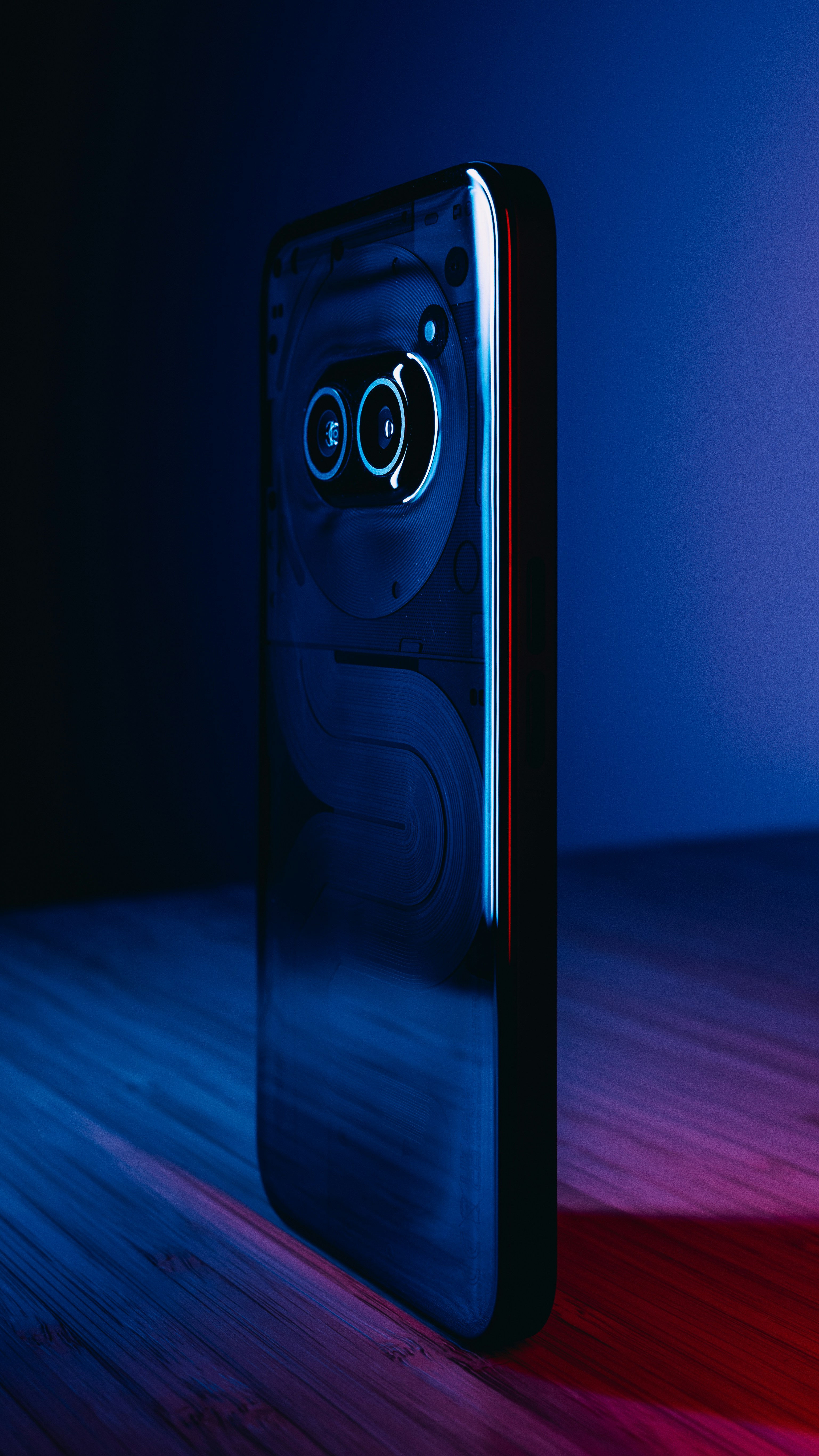 A cell phone is sitting on a wooden floor