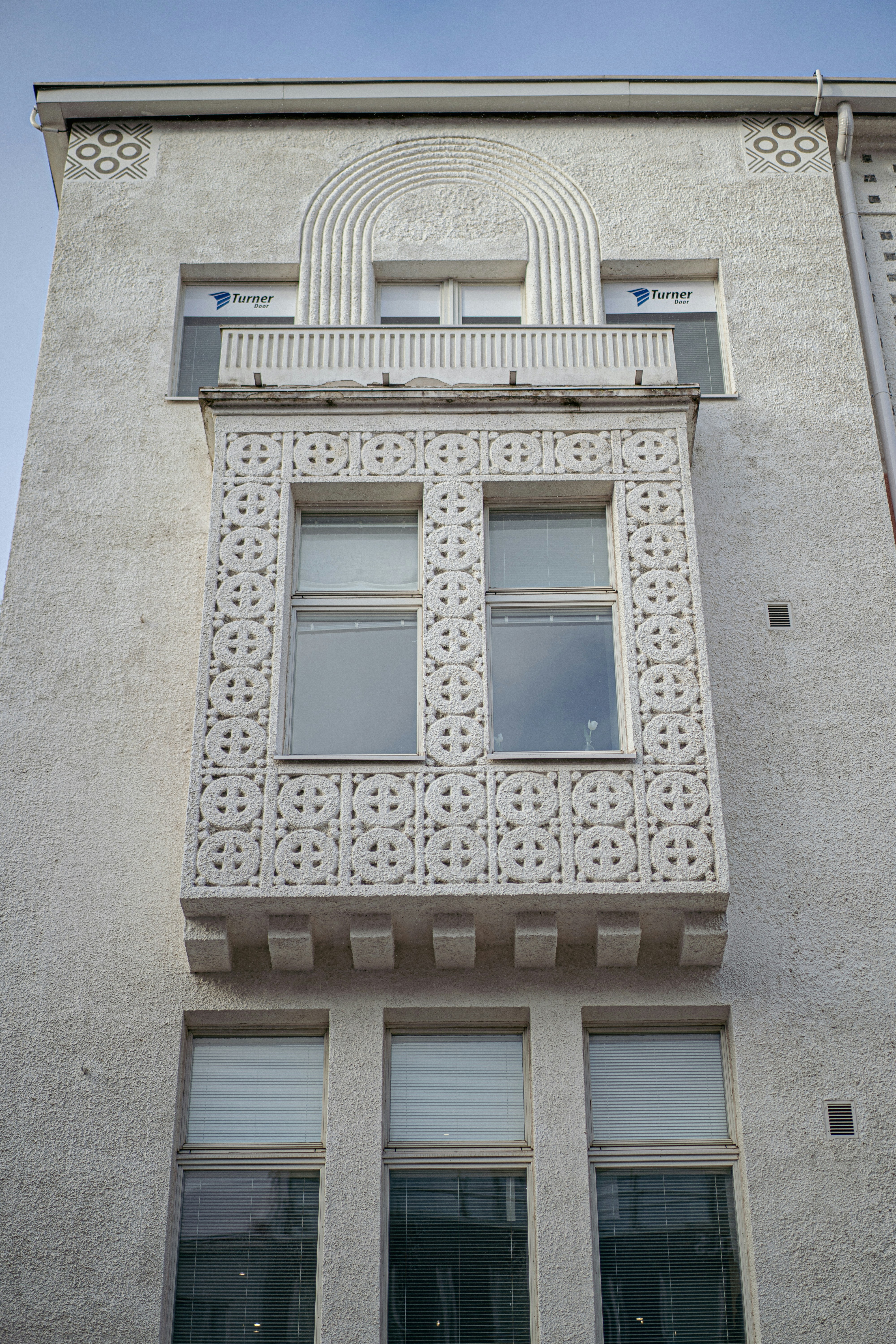 Circular Lacework Framing a City Window Panel