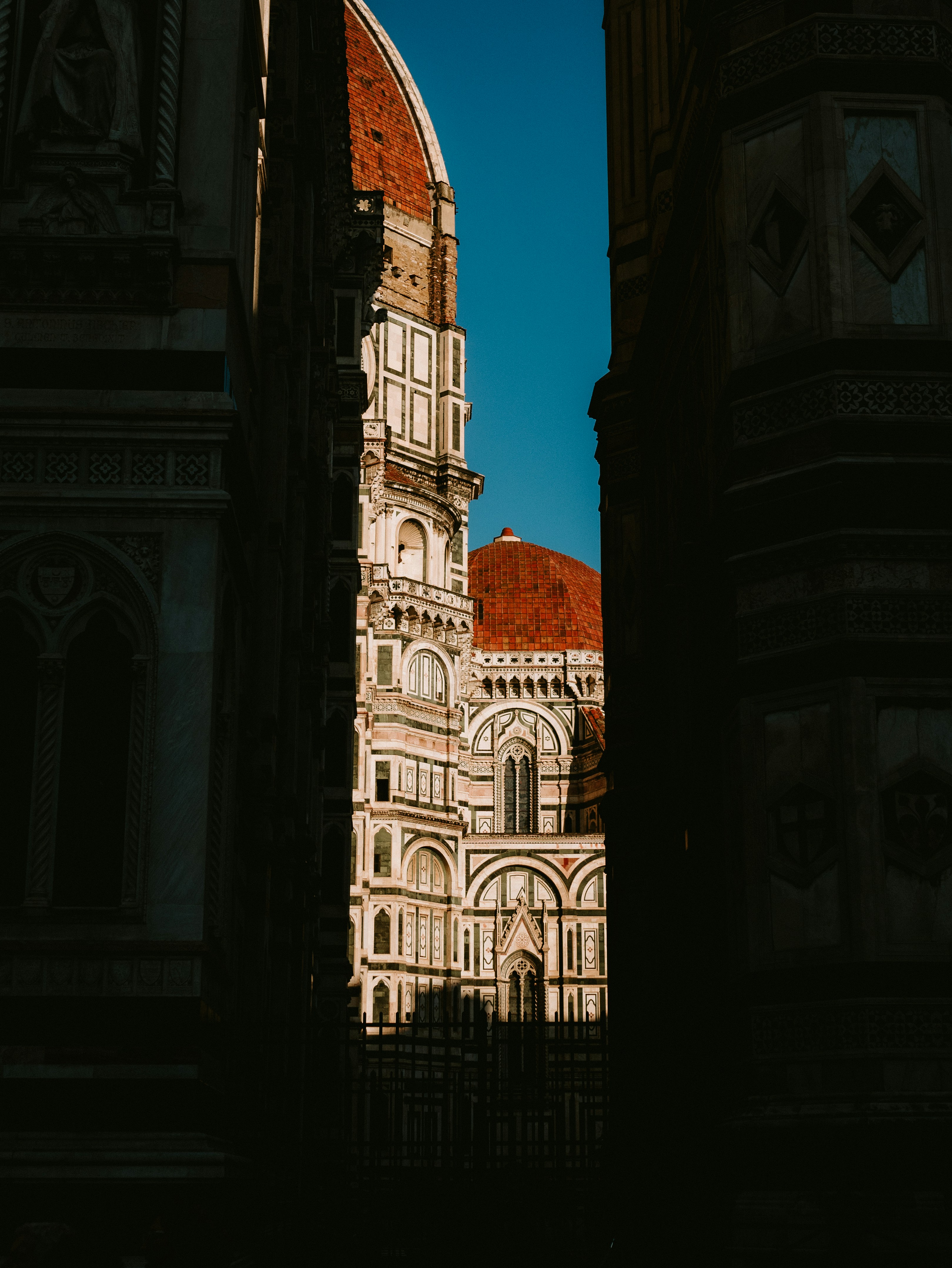 Radiant Florentine Facade Peering Through Shadowed Arches