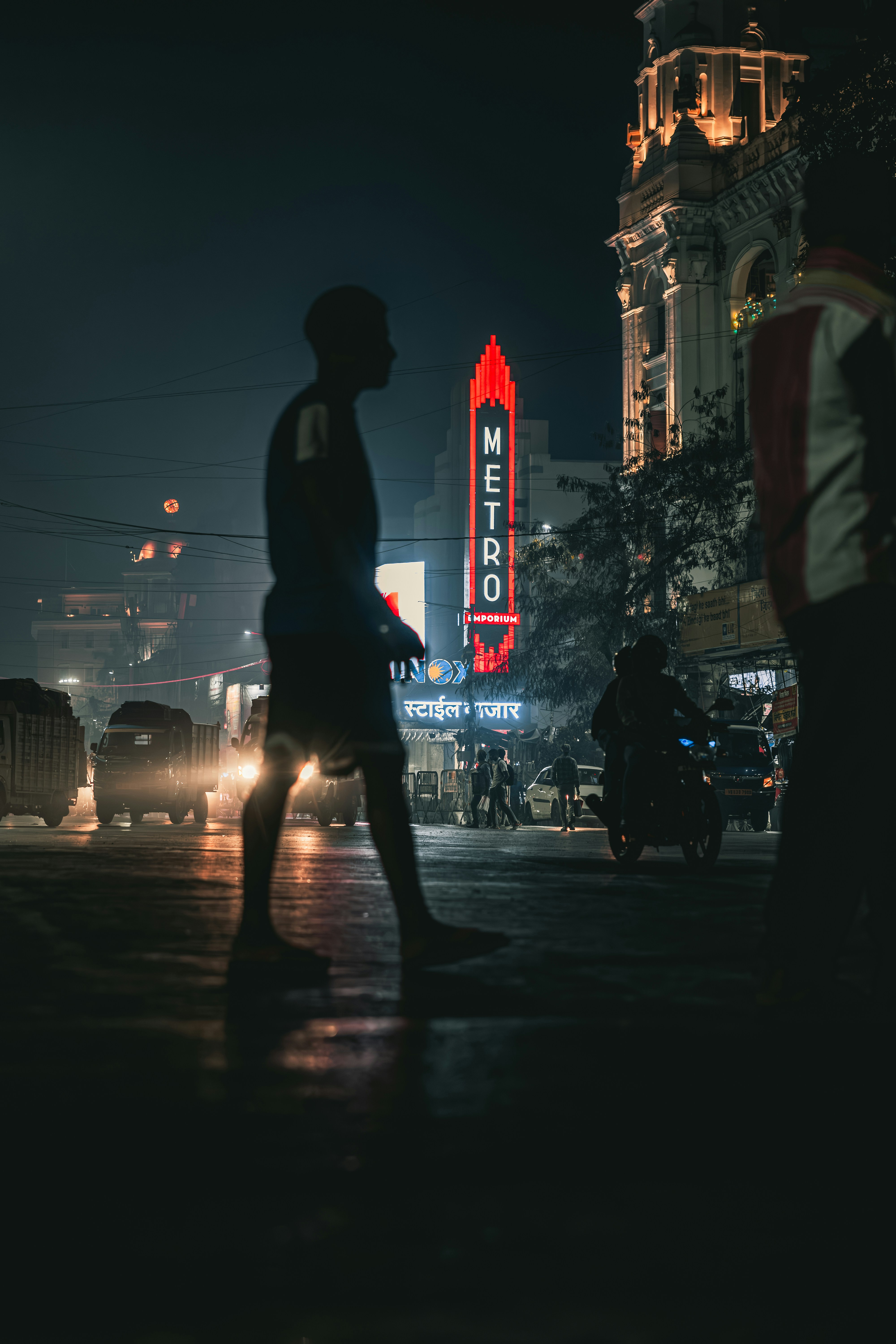 Midnight Neon: The Metro Sign Illuminating a City Street