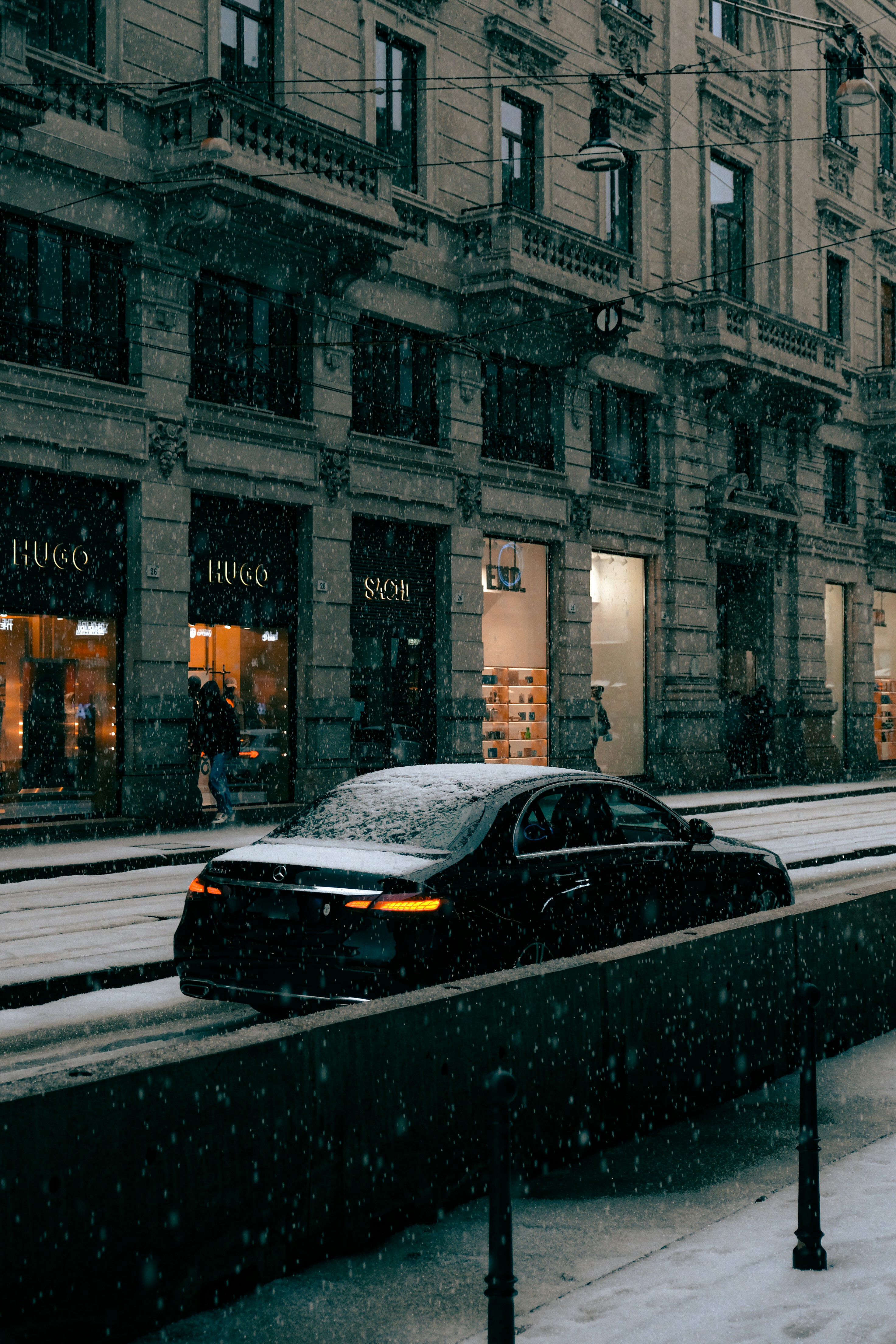 A car driving down a snow covered street photo – Free Street ...