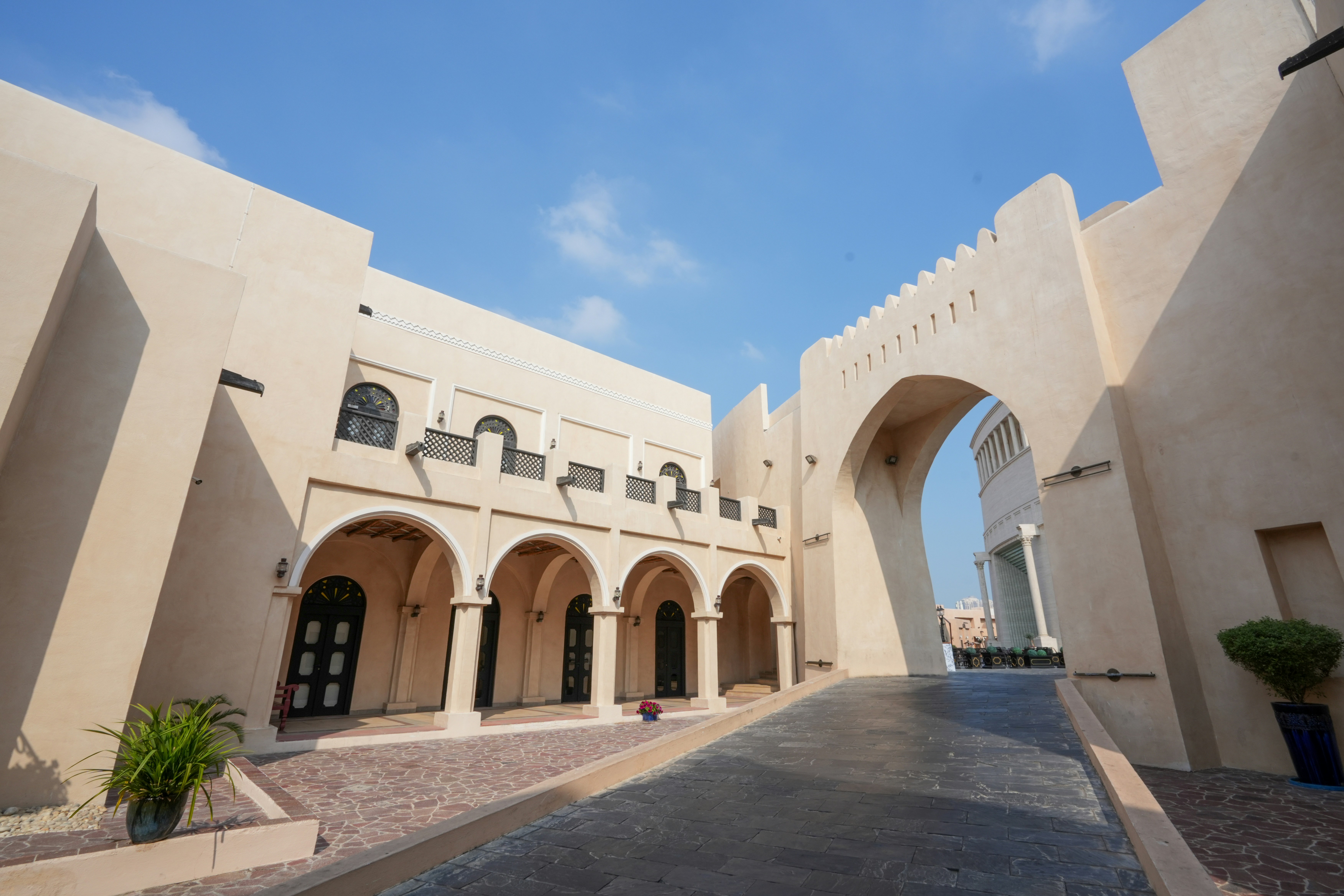 A large building with arches and arches on the side of it photo – Free ...