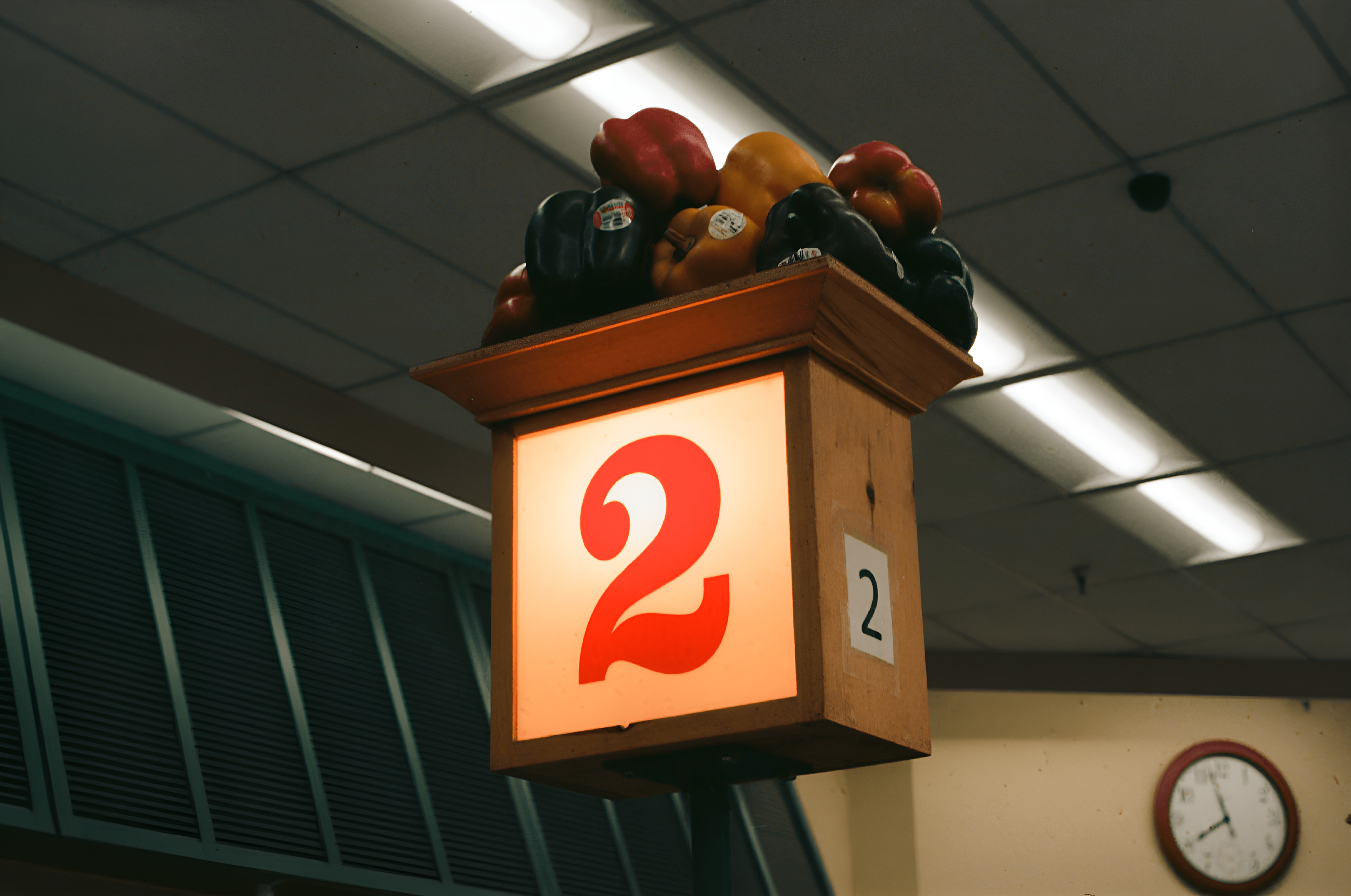 A sign that says 2 is hanging from the ceiling photo – Free Human Image ...