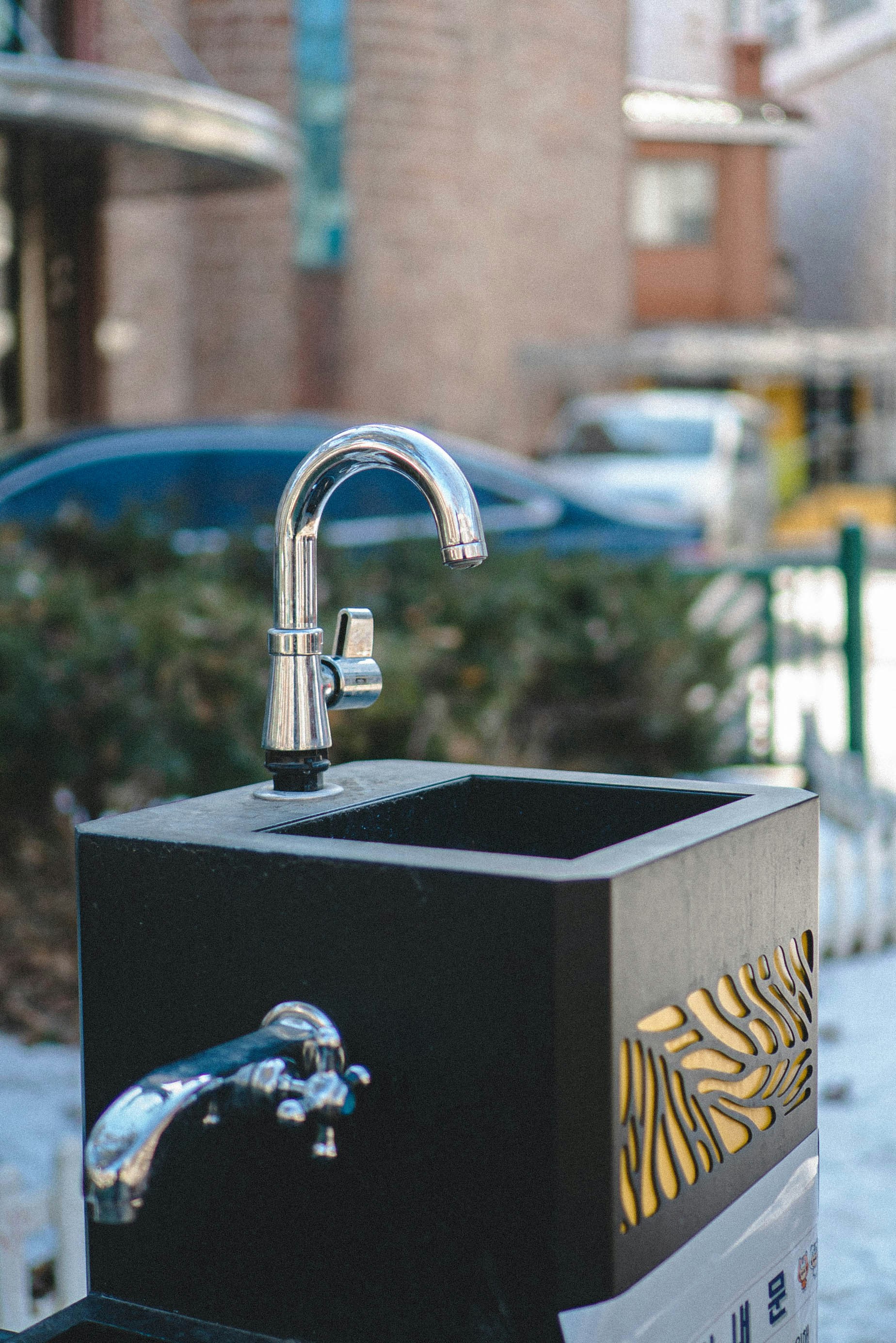 Chrome Spout in Frost: An Urban Fountain's Quiet Geometry