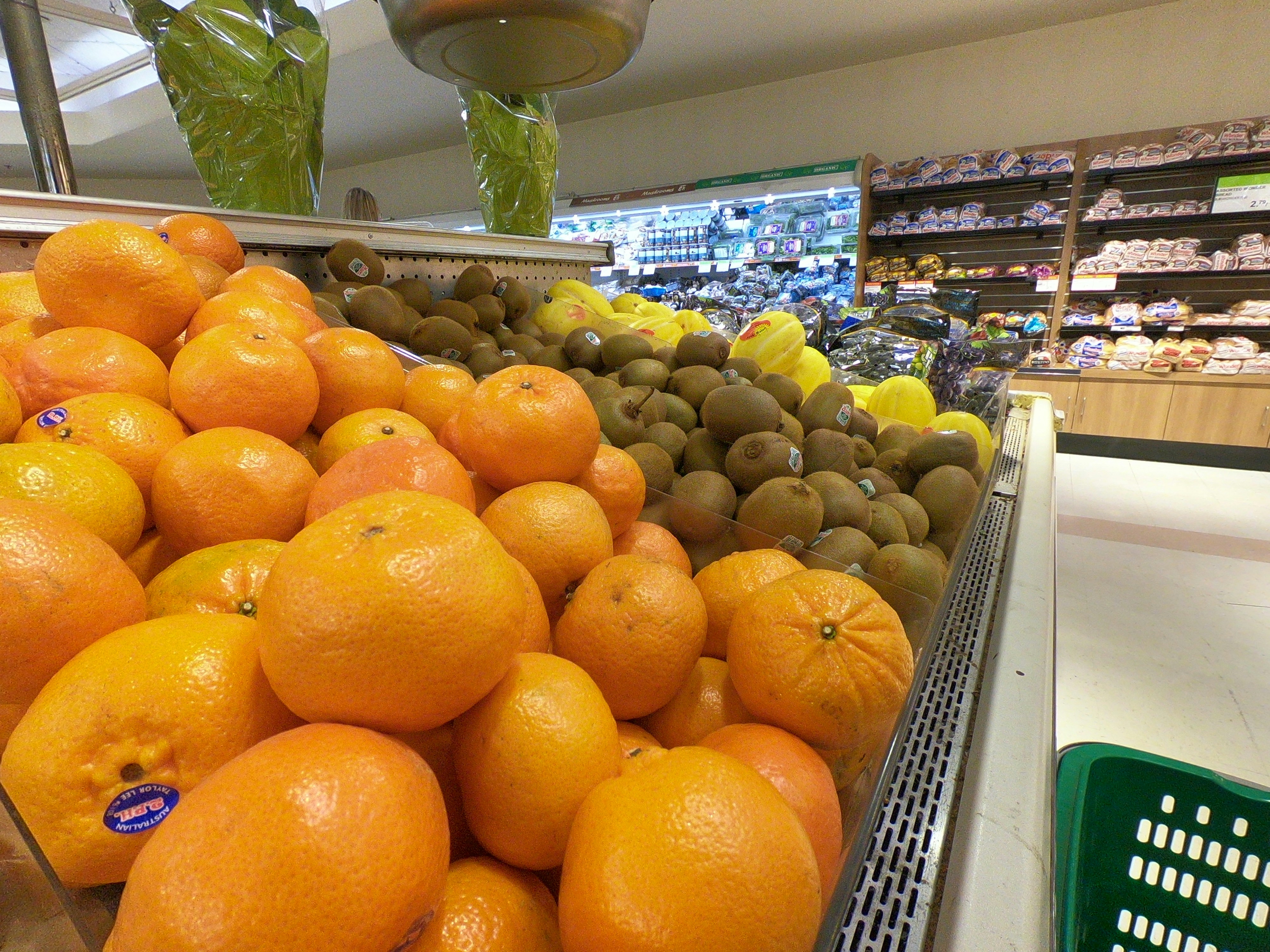 A display in a grocery store filled with lots of oranges photo – Free ...