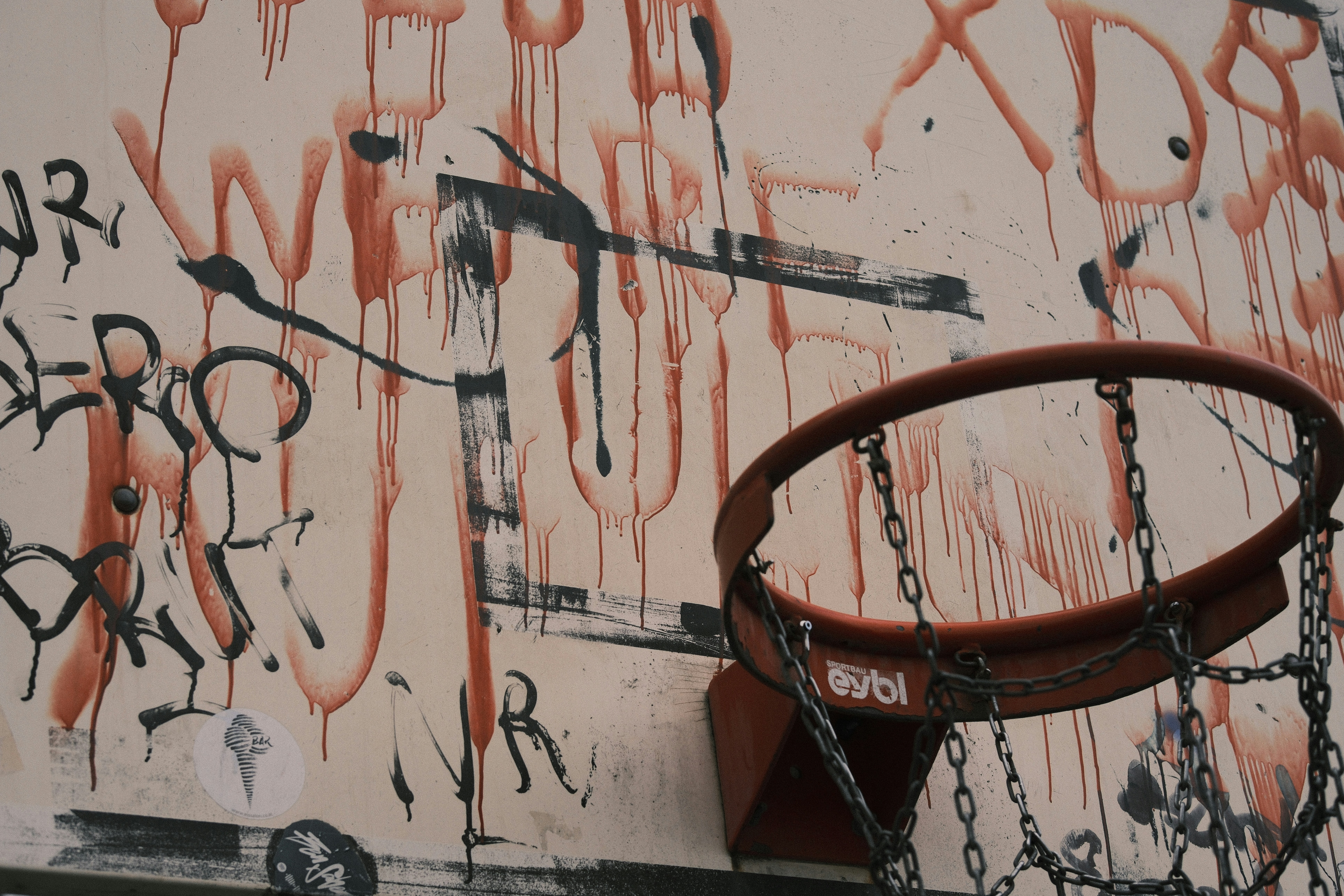 A basketball hoop hanging from the side of a wall photo – Free Human ...