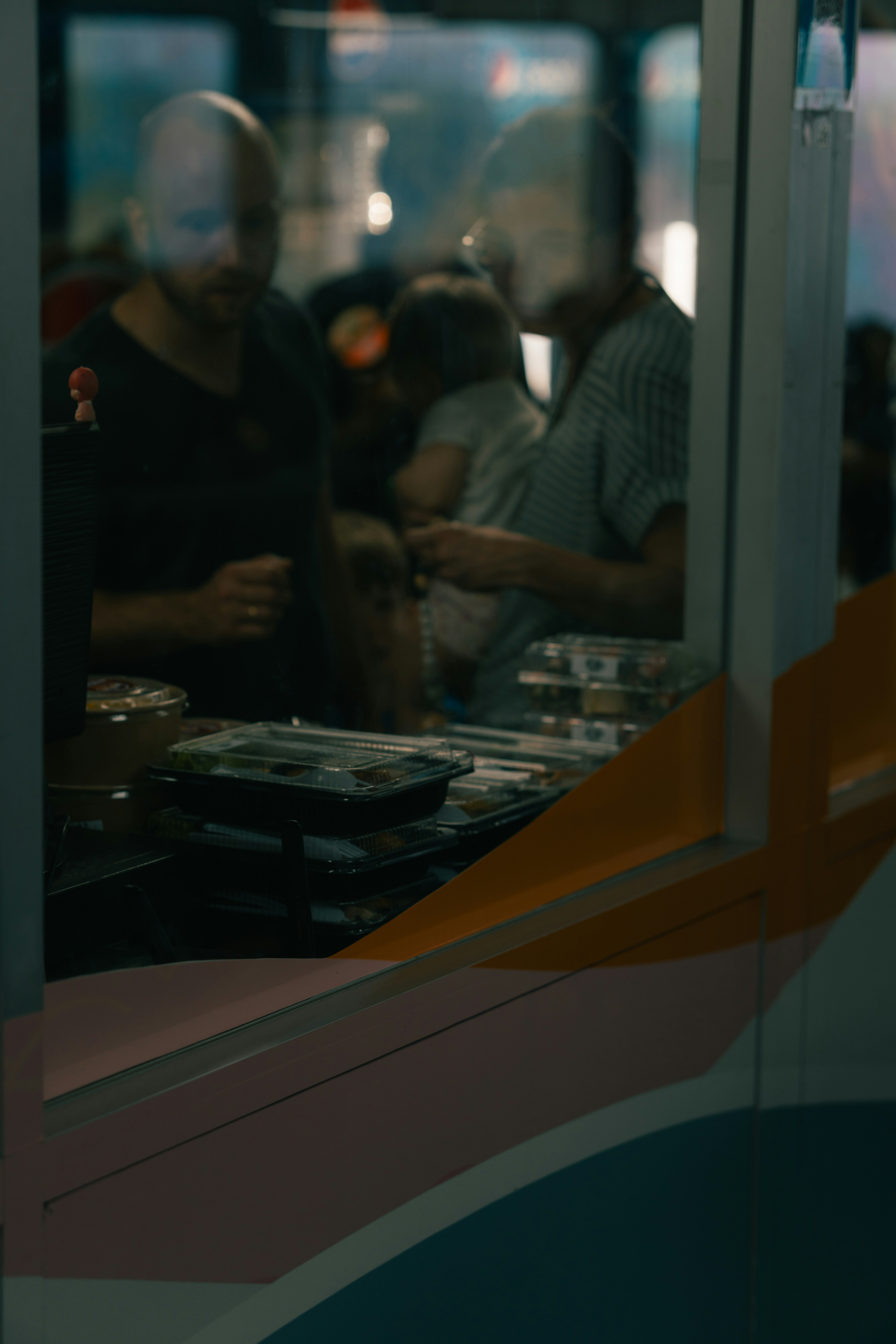 Dim Bus Window Portrait: Reflections Around a Countertop Gadget
