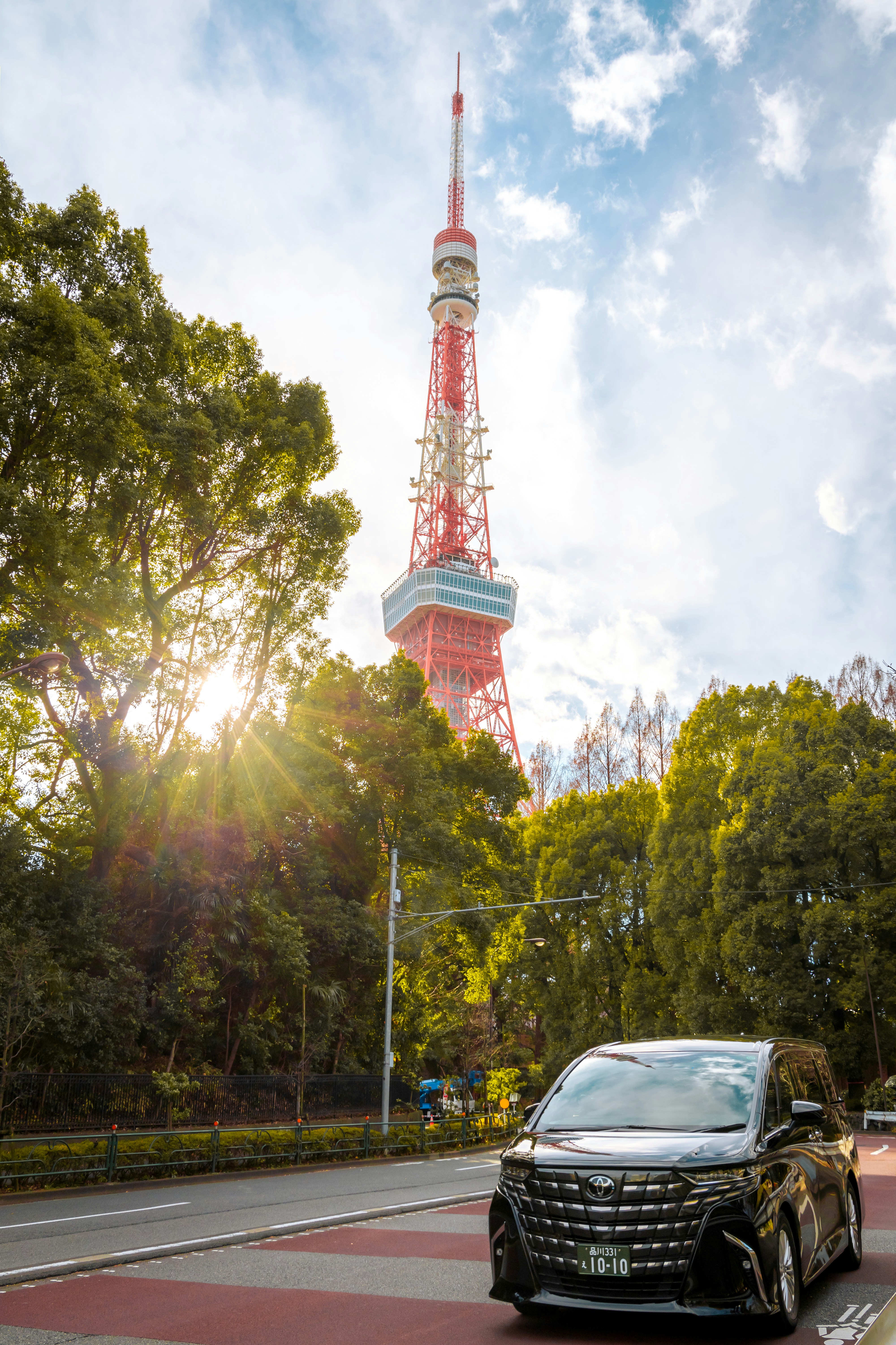 Sunlit Tokyo Tower Rise Over Verdant Street