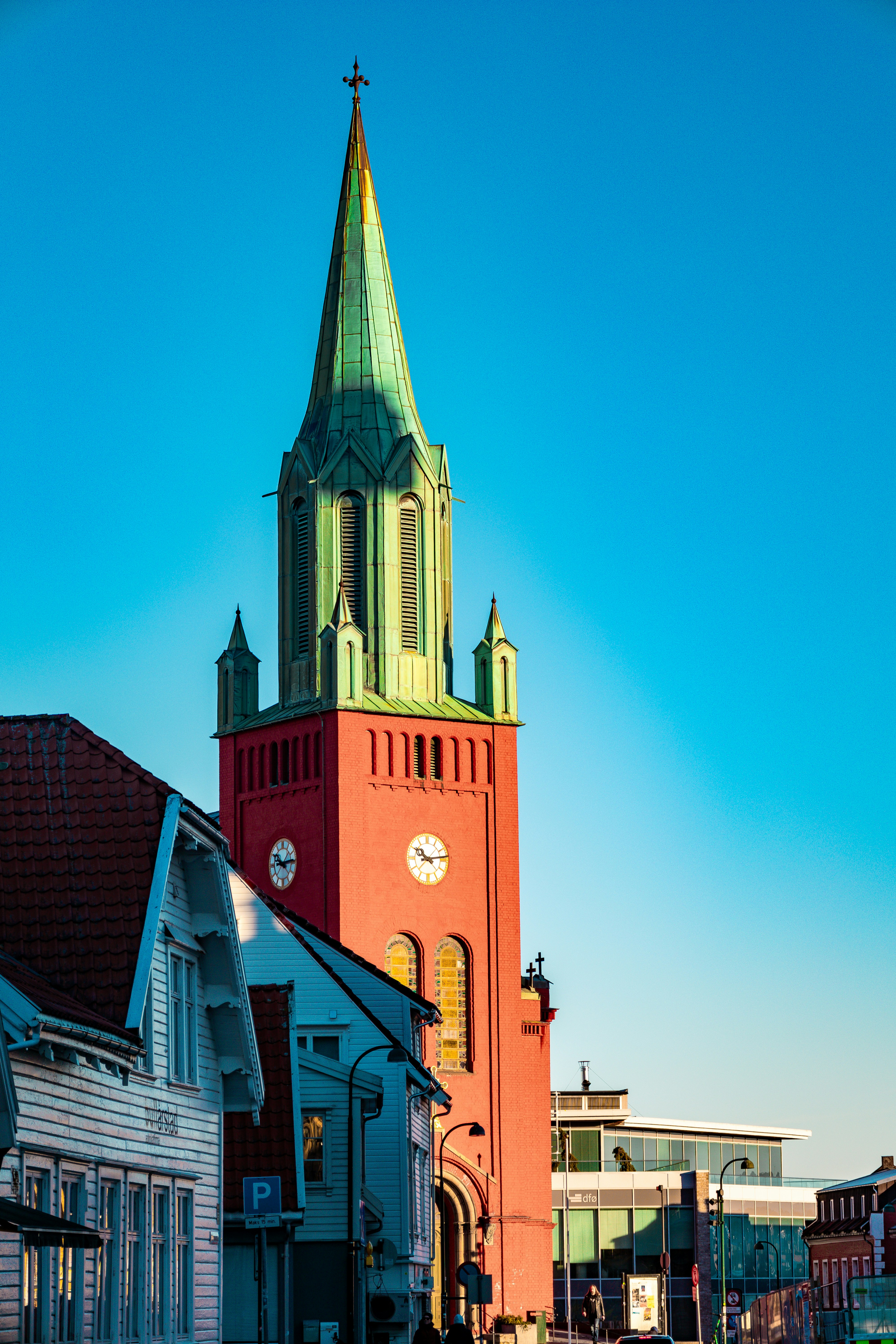 Verdigris Spire Over Red Brick Clocktower Against a Cerulean Sky