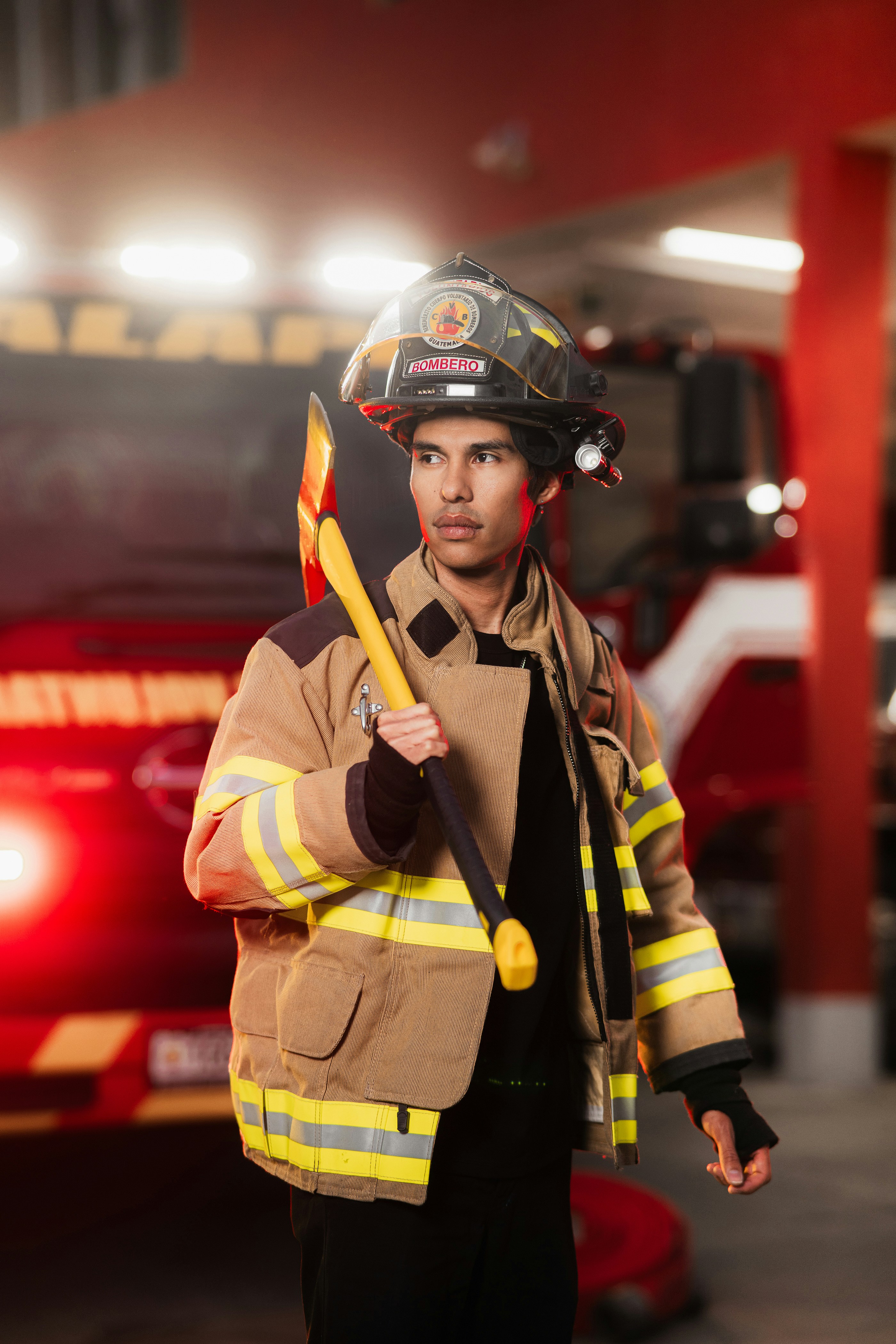A man in a fireman's uniform holding a baseball bat photo – Free Fire ...