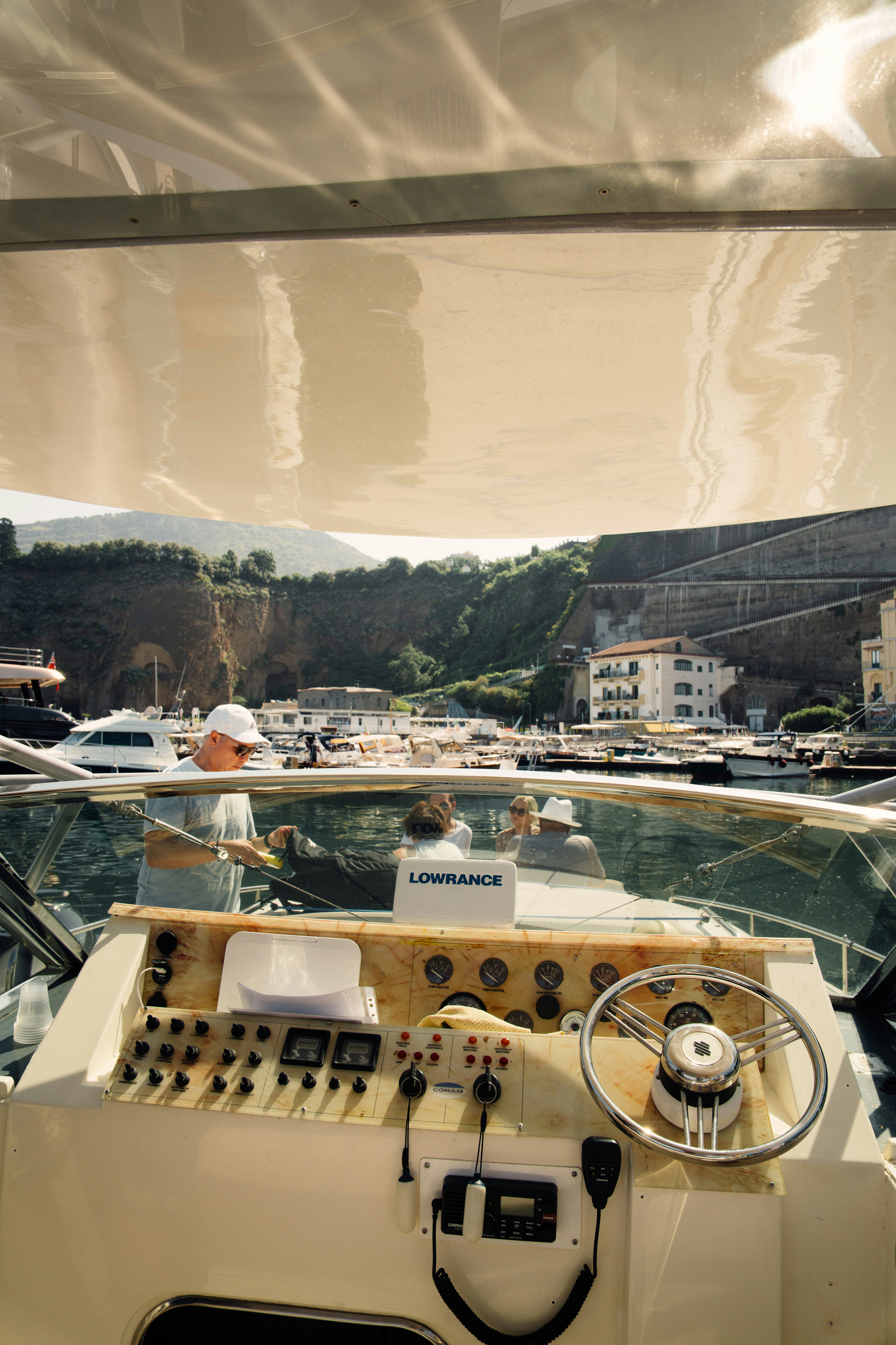 Harbor Helm: Sunlit Yacht Cockpit Framing a Quiet Marina