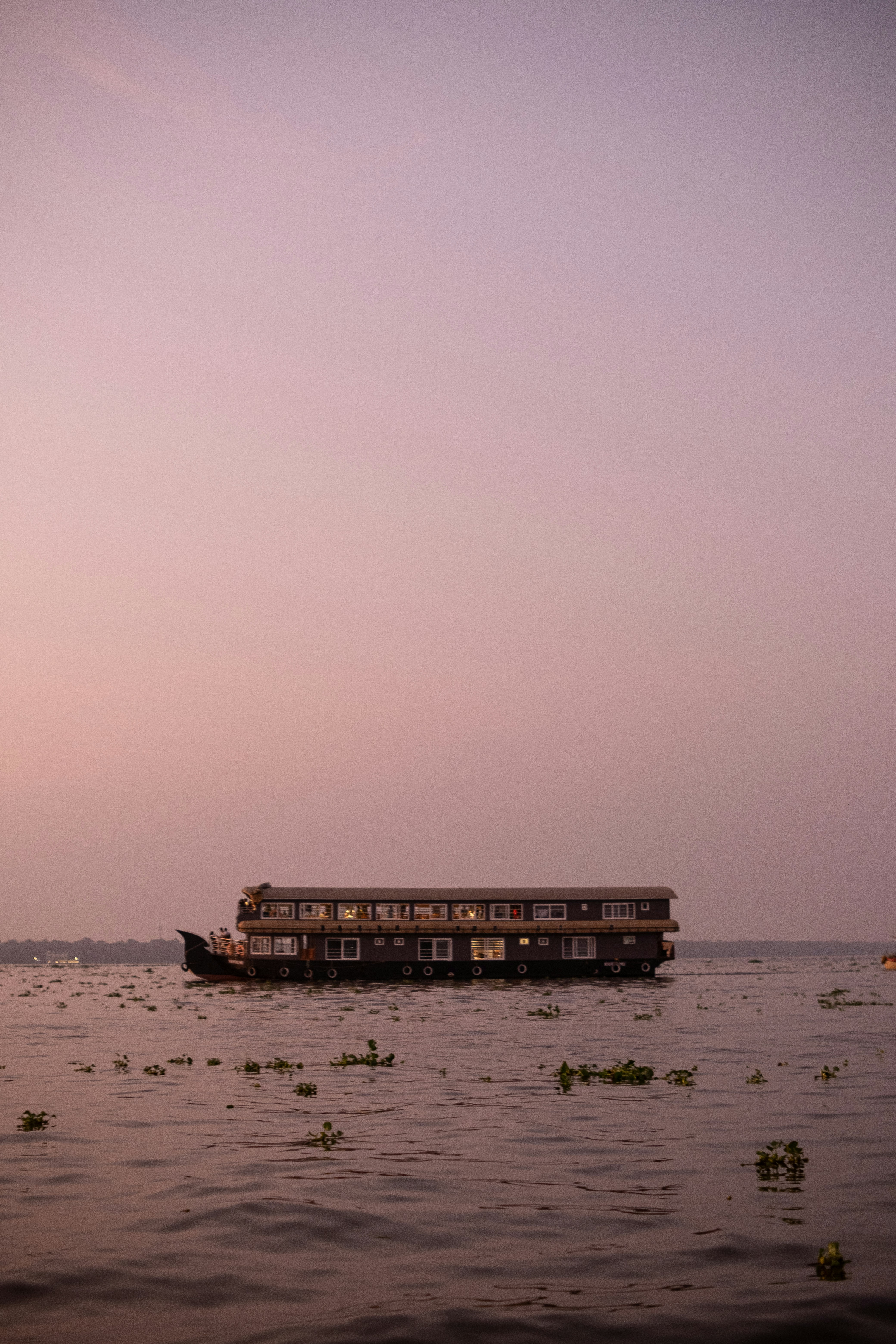 Pastel Dusk: The Houseboat Drifts Across a Quiet Bay