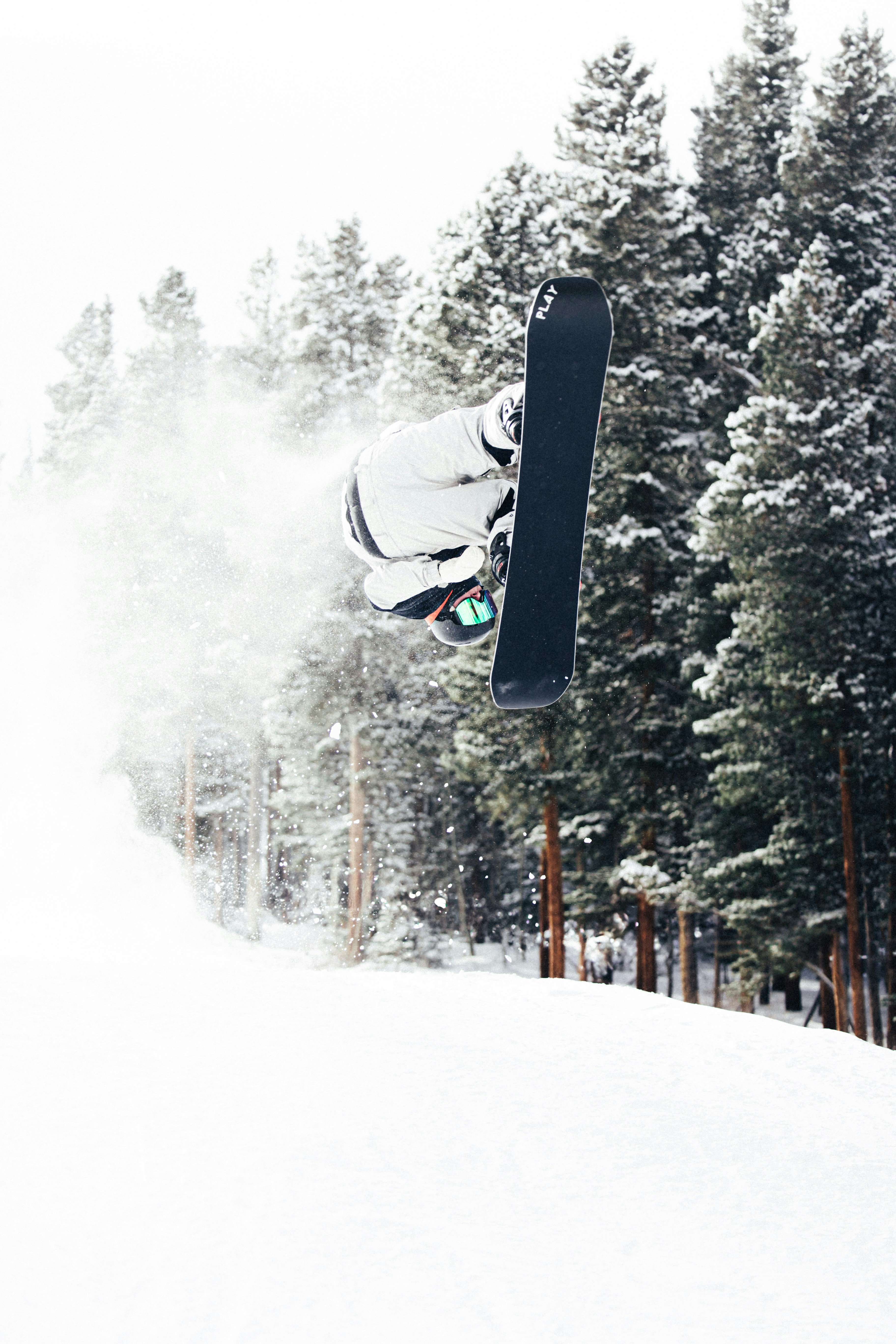 A man flying through the air while riding a snowboard photo – Free Man ...