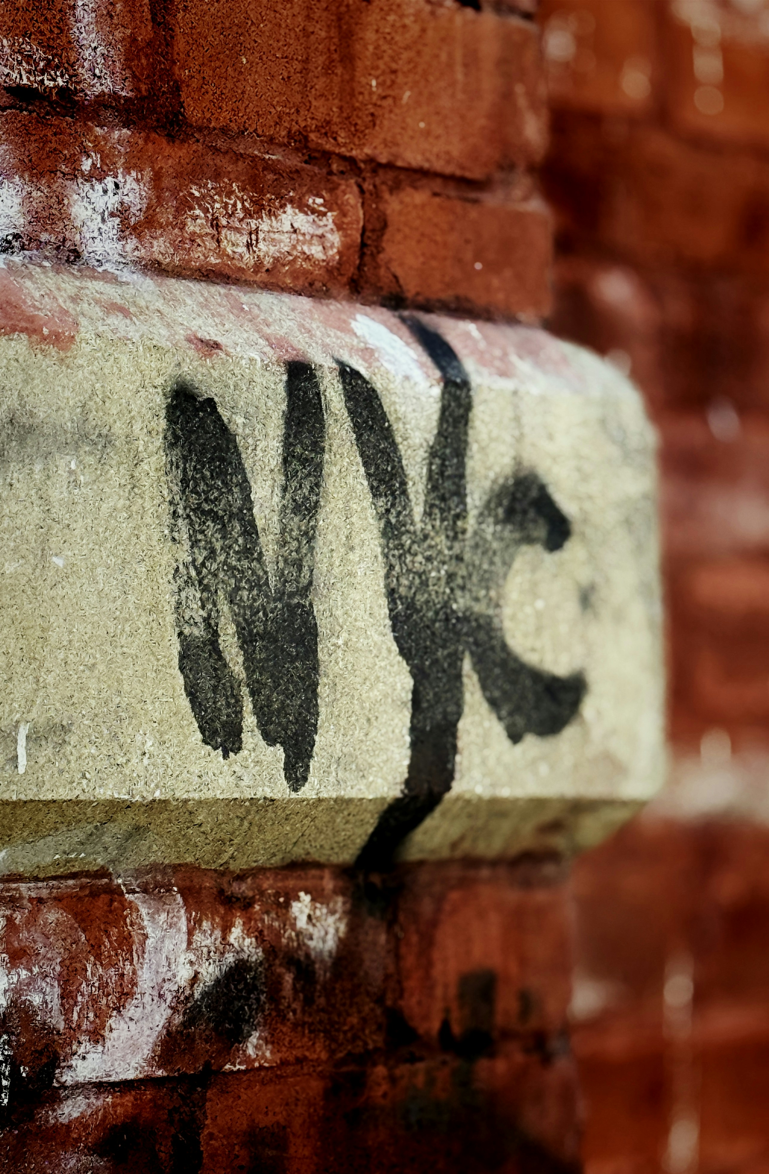 A close up of a brick wall with graffiti on it
