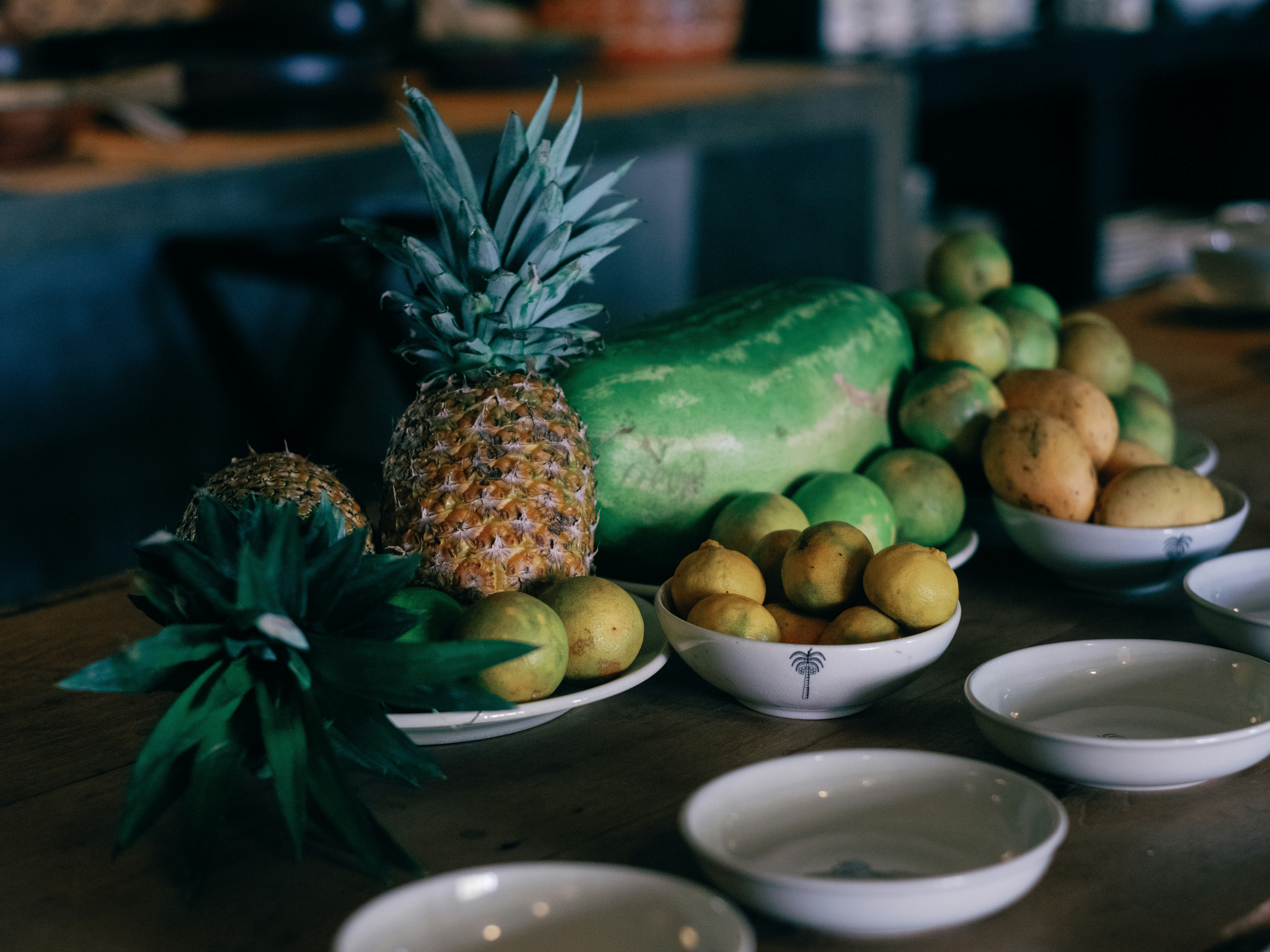 A wooden table topped with bowls of fruit photo – Free Fruit Image on ...