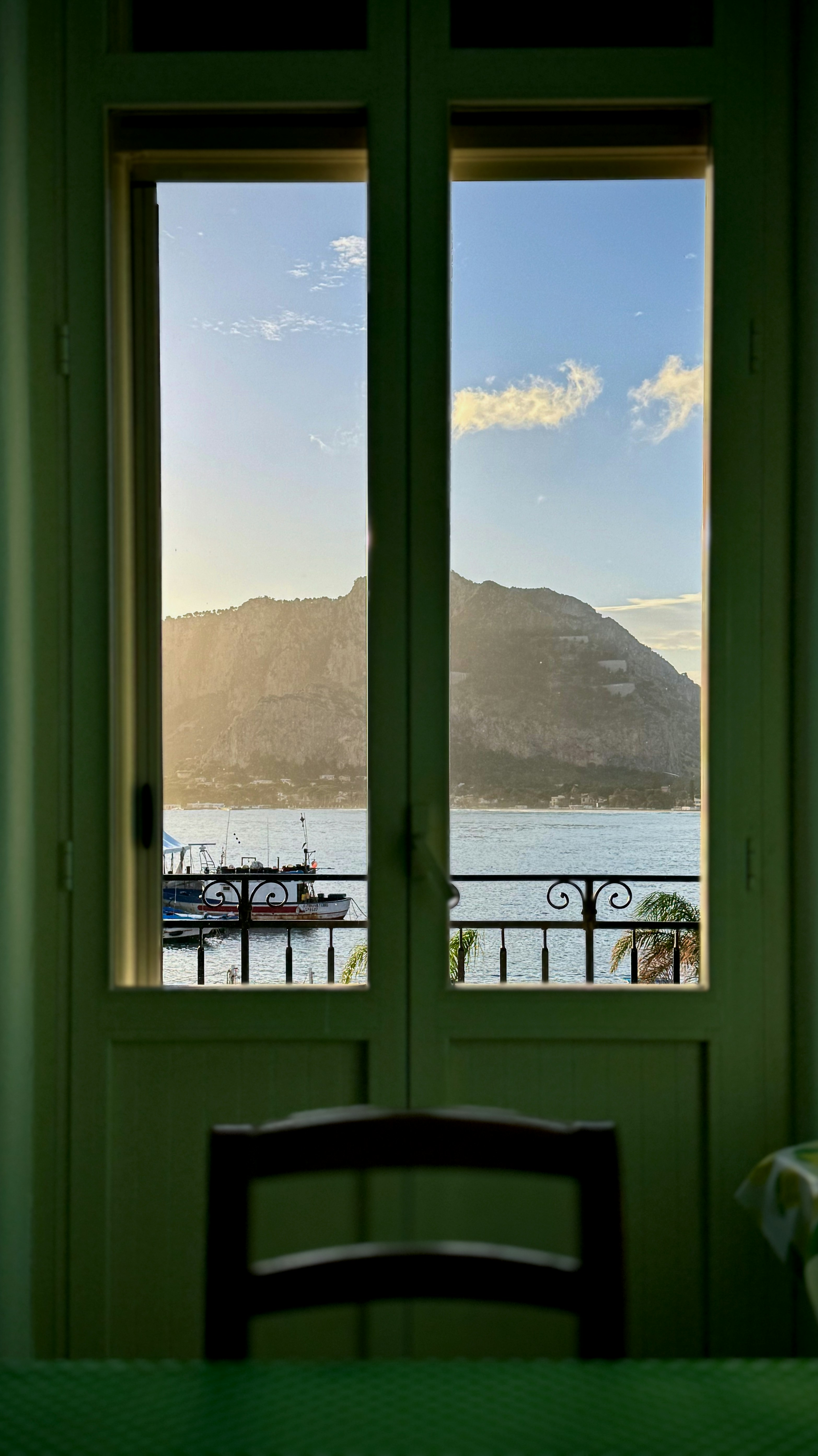 A green room with a view of a bay and mountains photo – Free Nature ...