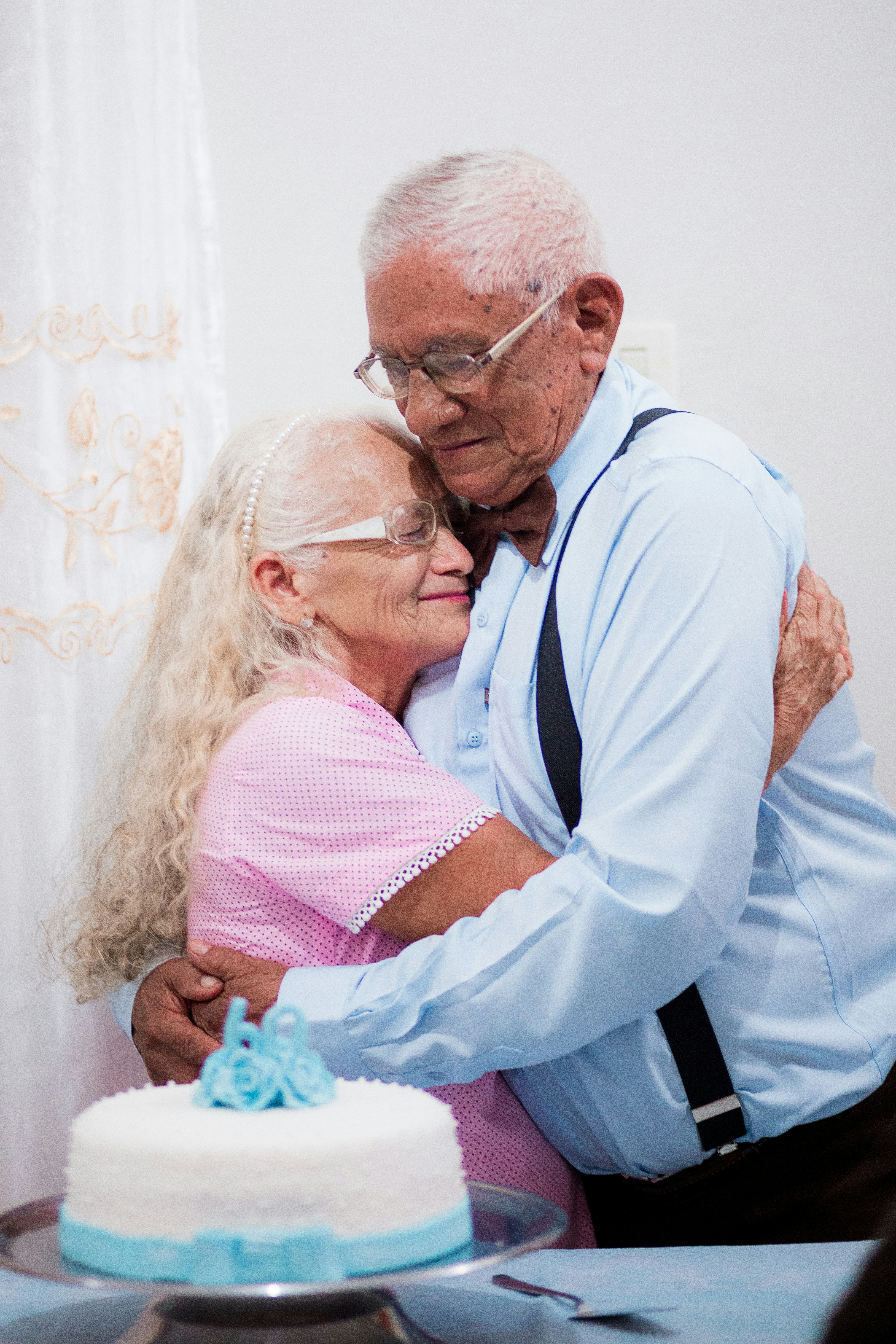 A man and woman hugging each other in front of a cake photo – Free Food ...