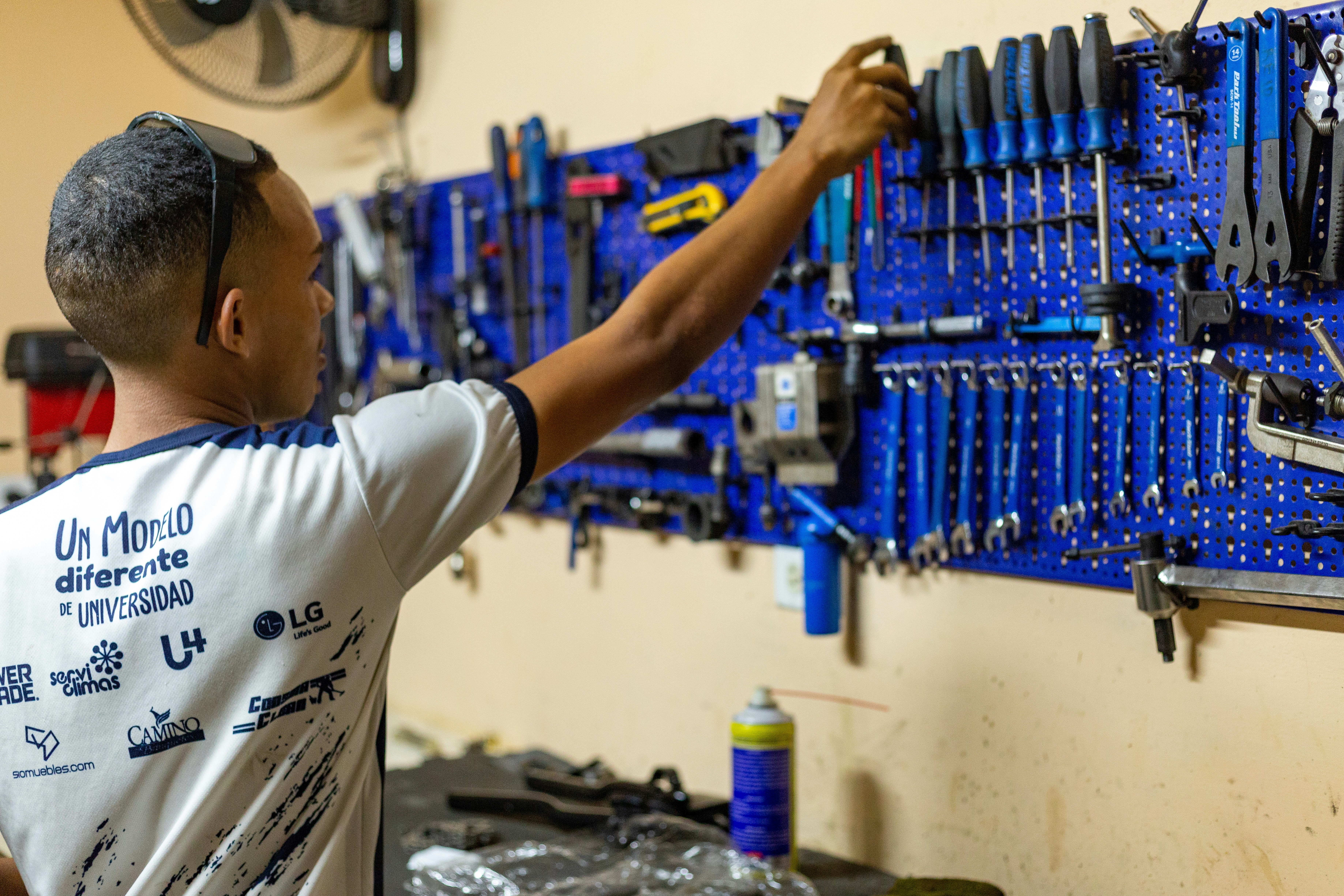 A man working on a wall of tools photo – Free Man Image on Unsplash