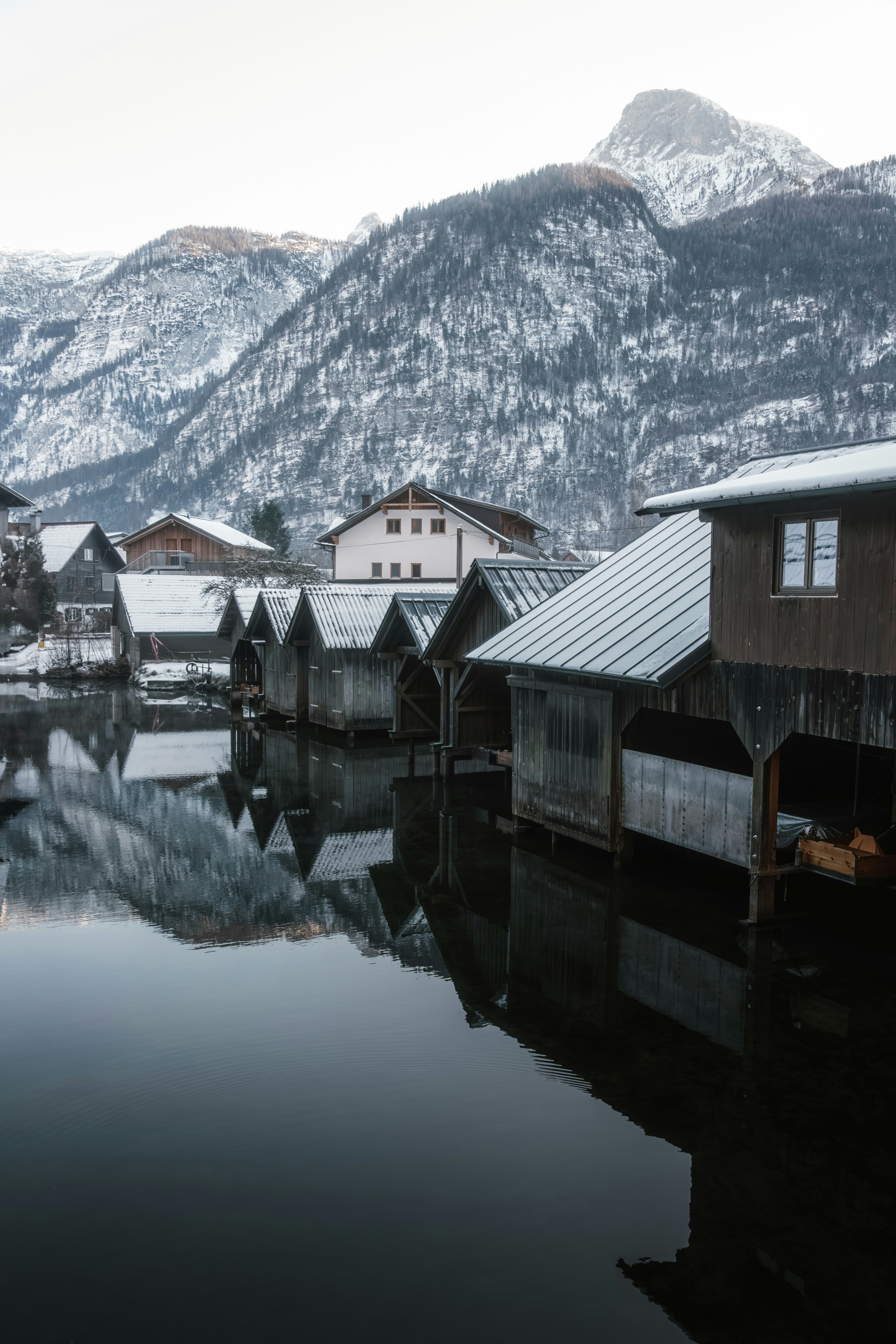 Reflections on a Snow-Kissed Boathouse Row Beneath Alpine Peaks
