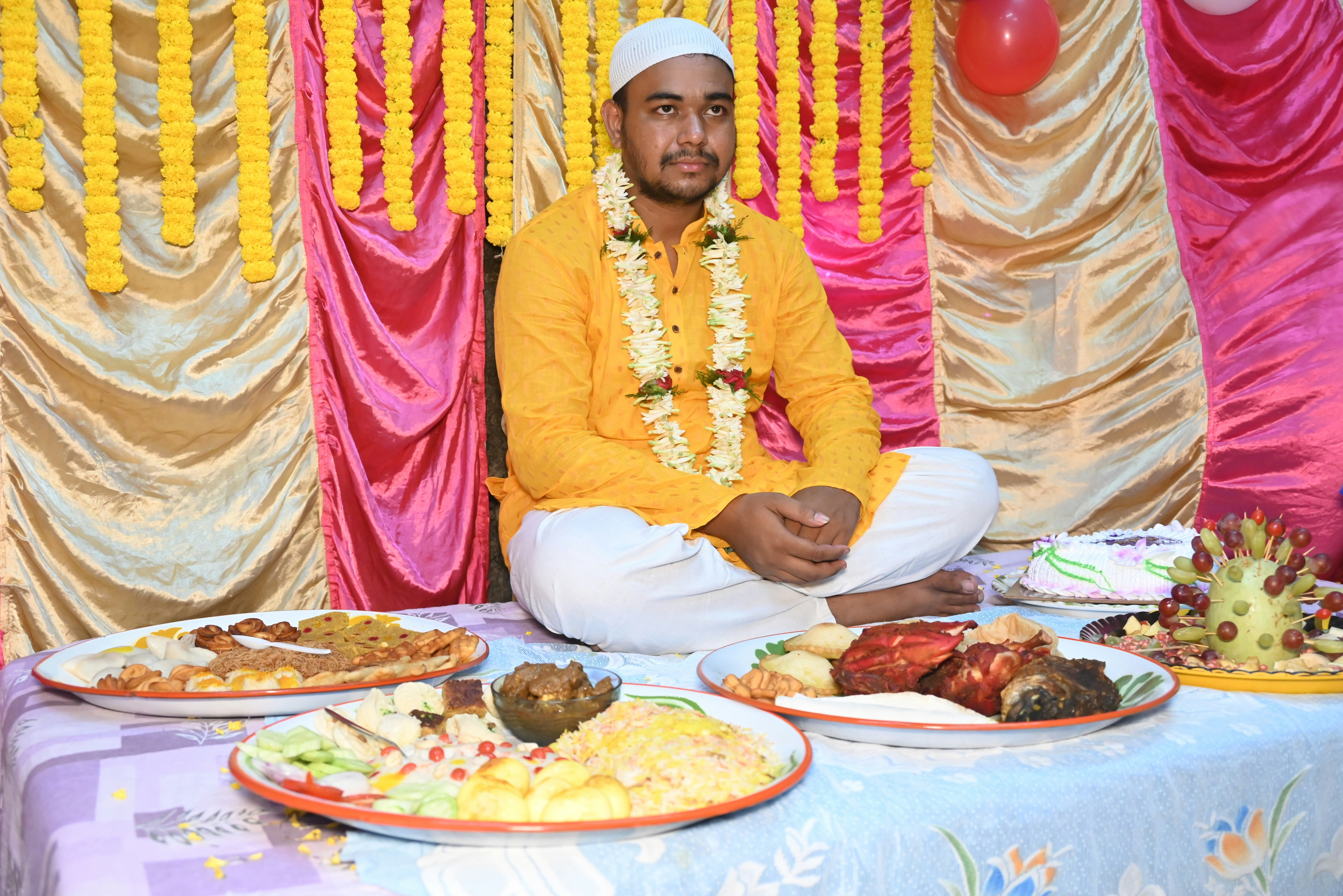 A man sitting in front of a table filled with food photo – Free Food ...