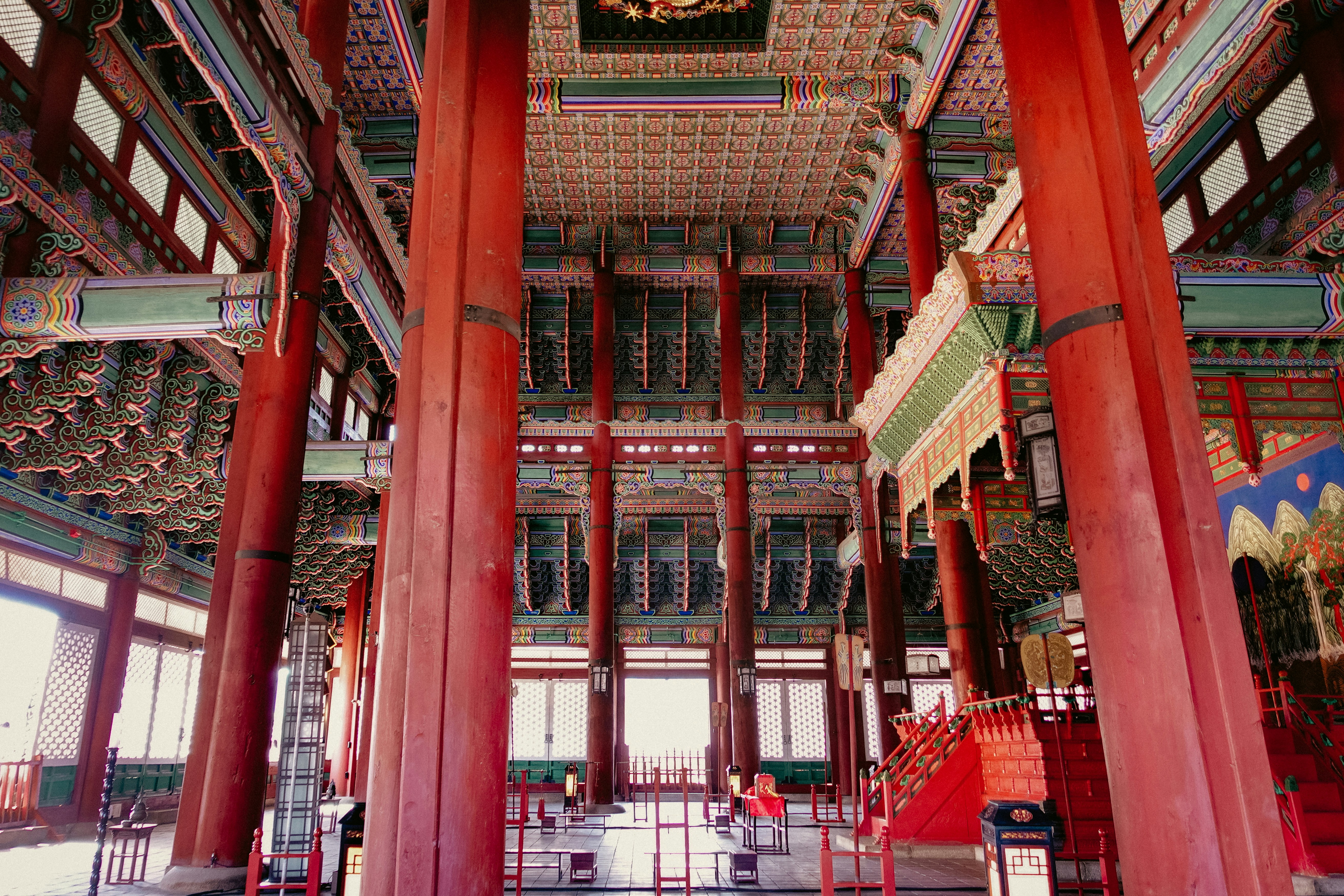 A large building with red pillars and a clock on the ceiling photo ...