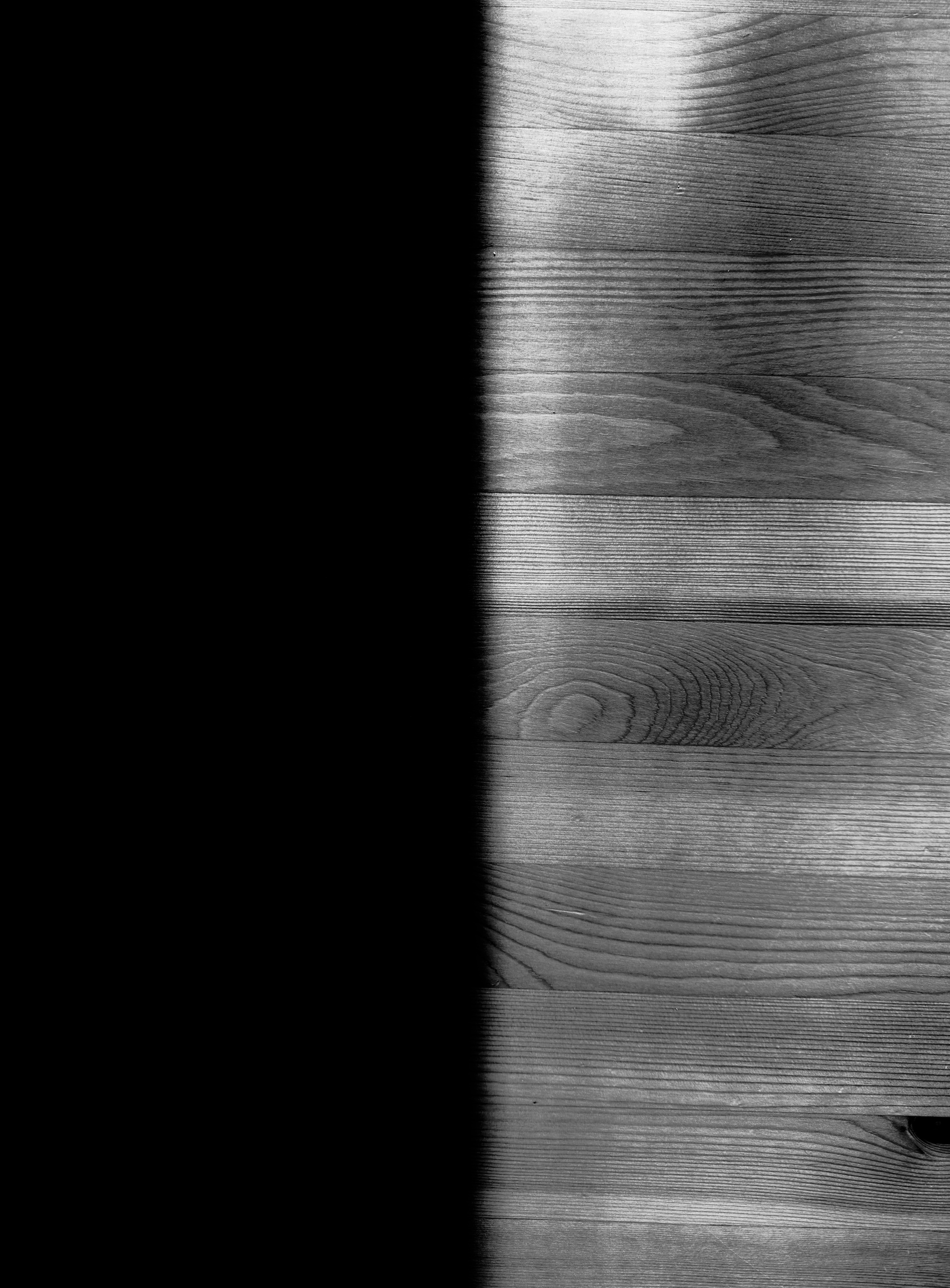 Threshold of Grain: Shadowed Verge Across Weathered Planks