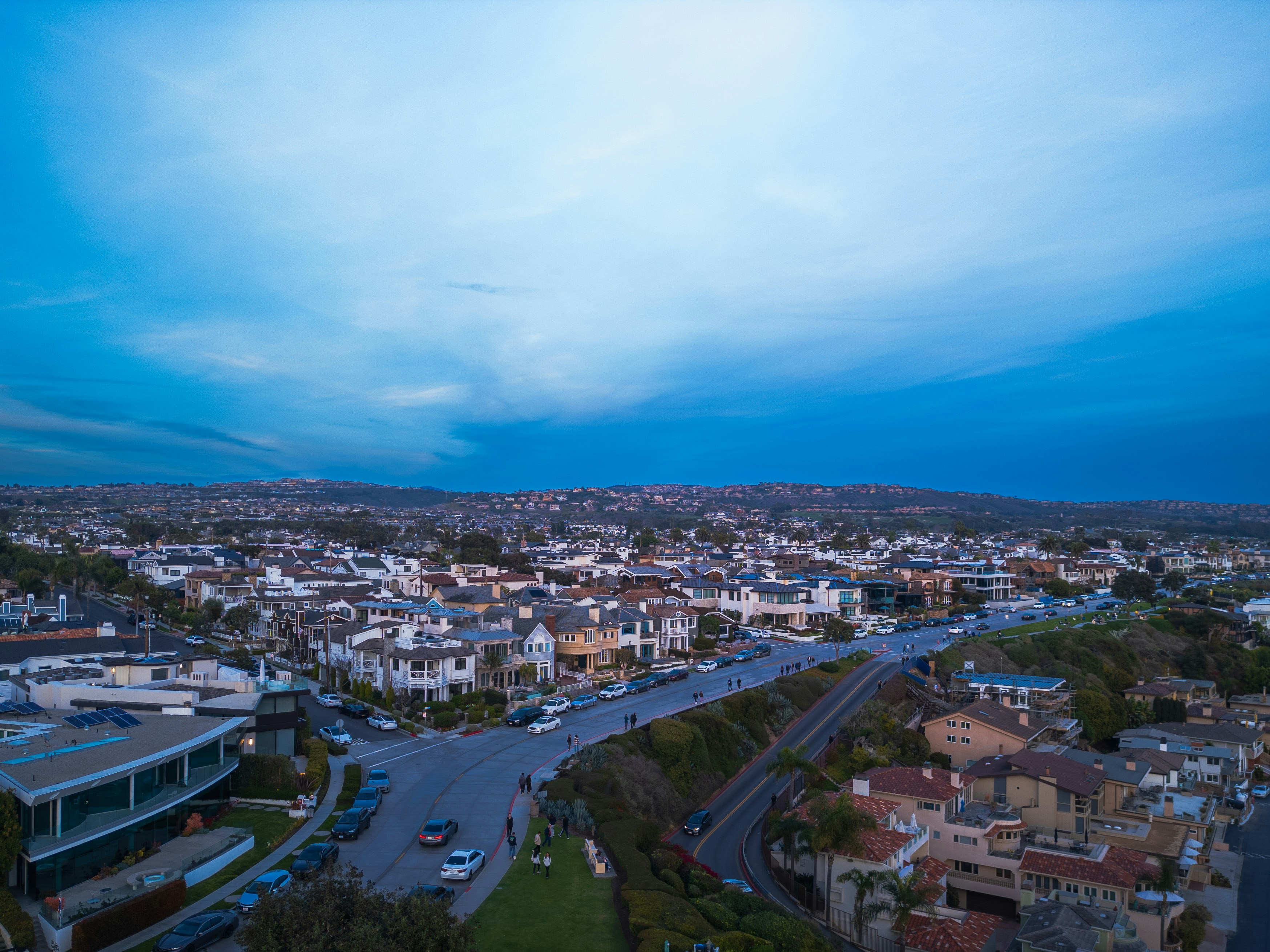 Expansive view of a cityscape under a vast, blue evening sky.