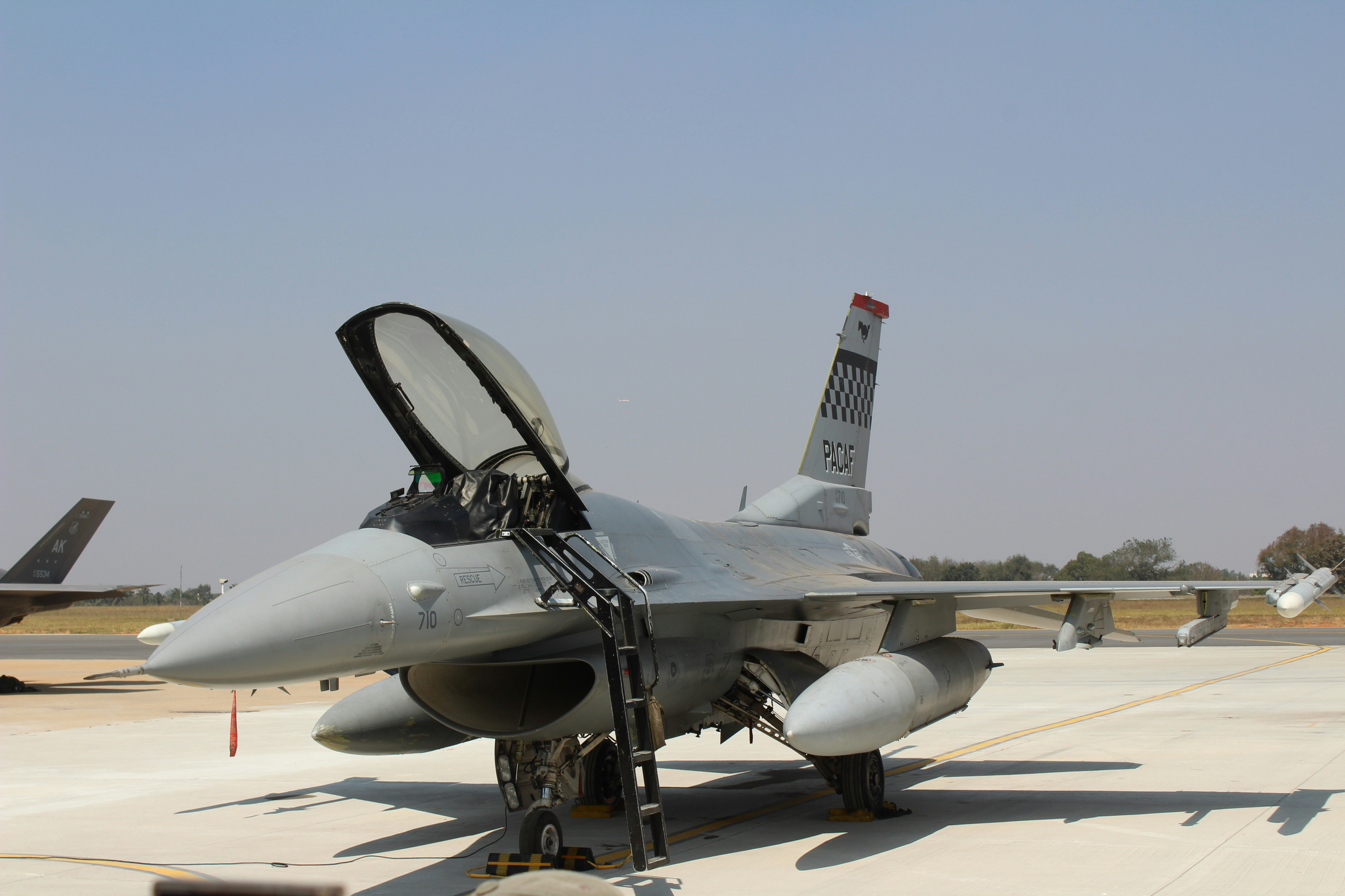 A fighter jet sitting on top of an airport tarmac photo – Free Air ...