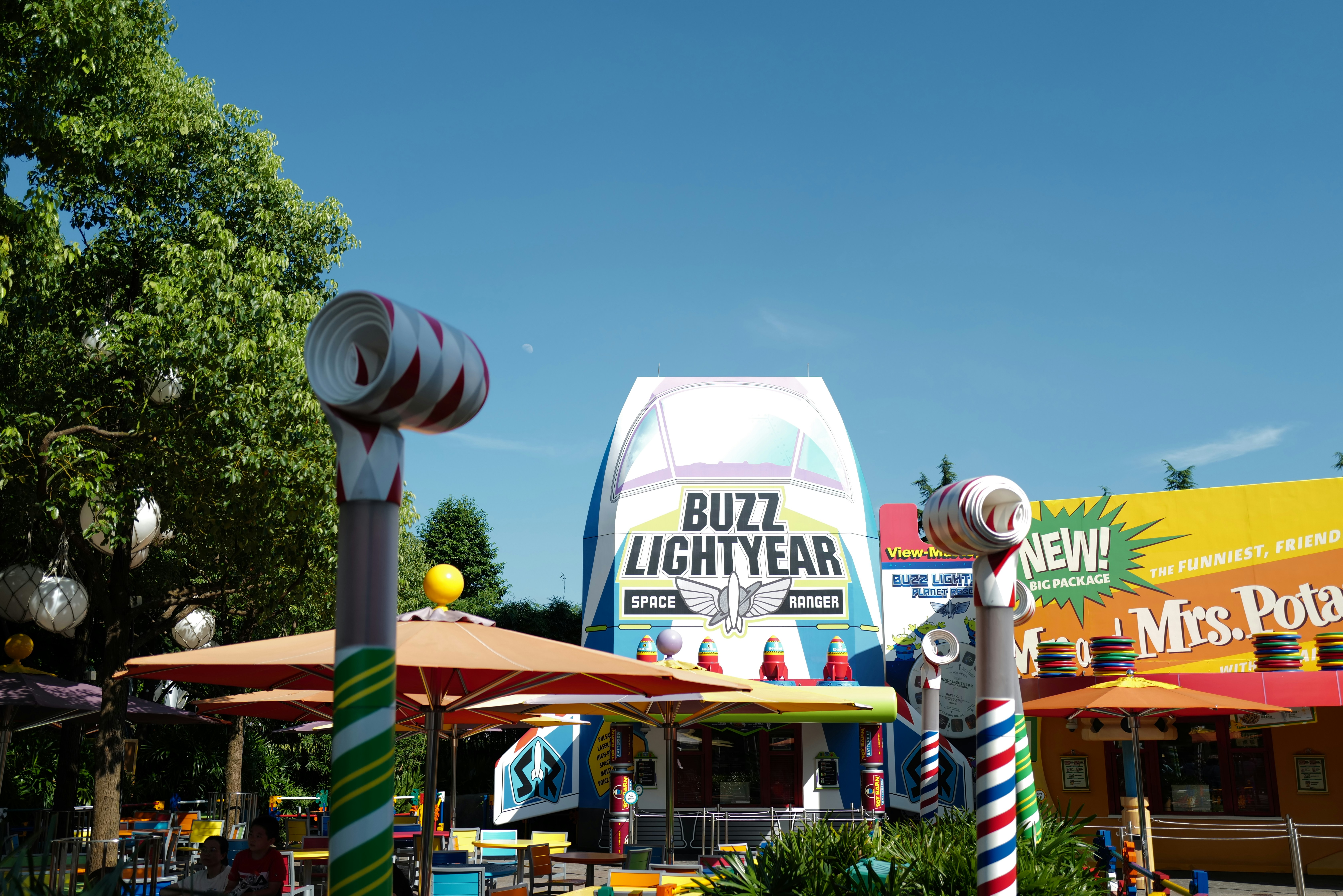 Buzz Lightyear Arcade Sign Anchors a Sunlit Carnival Scene
