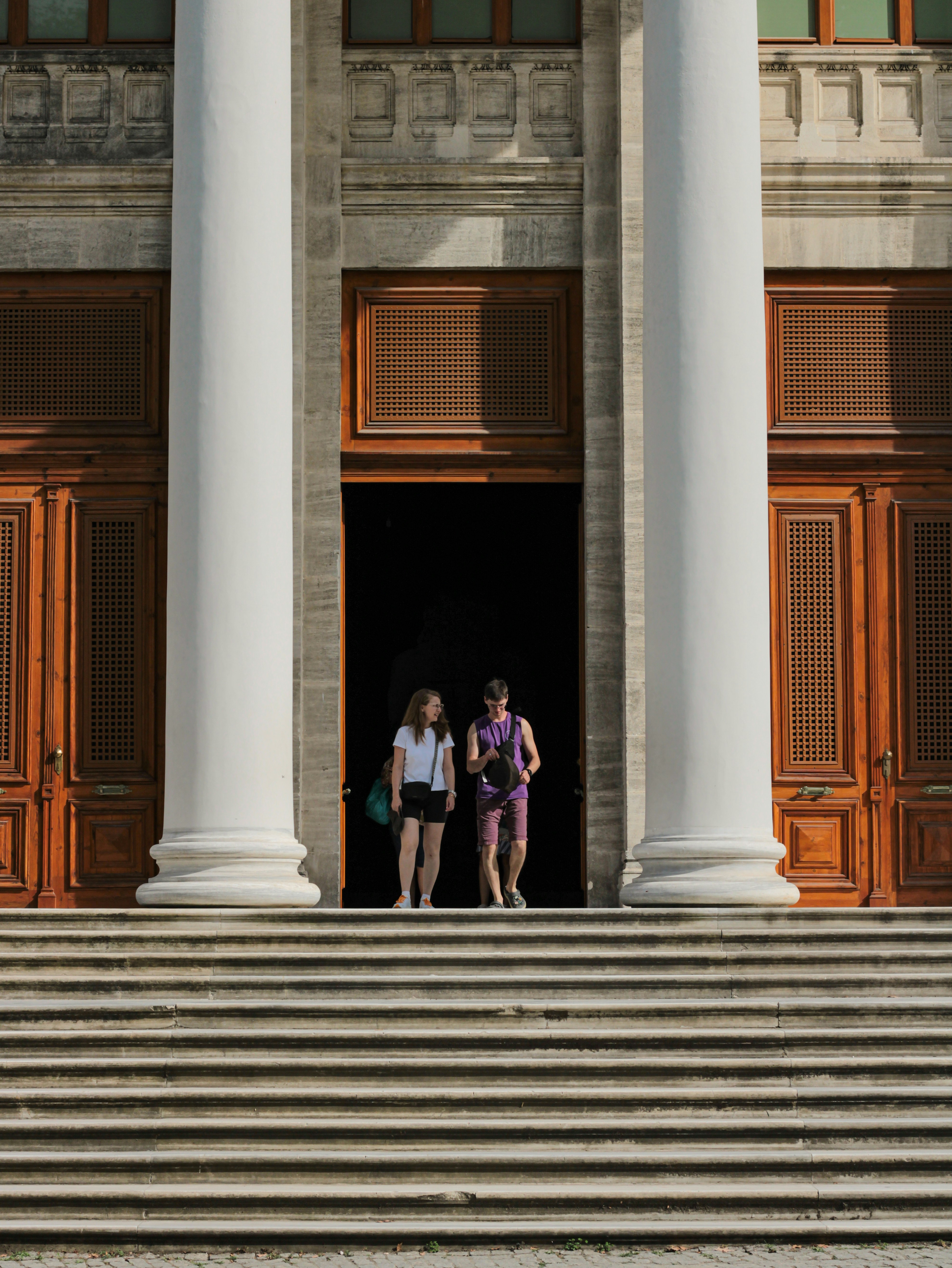 Threshold of Marble: Two Travelers at the Grand Entrance