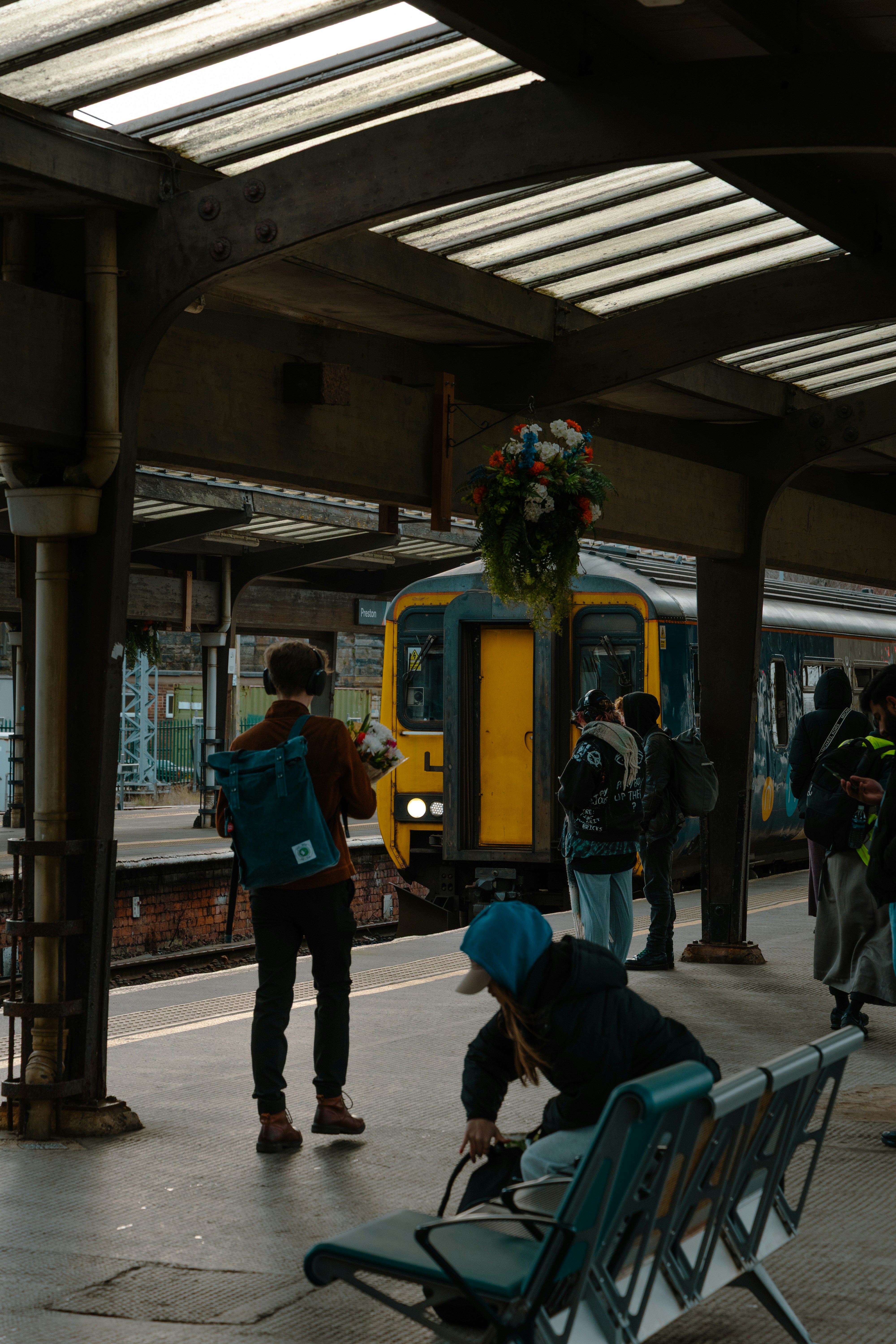 A group of people waiting for a train at a train station photo – Free ...