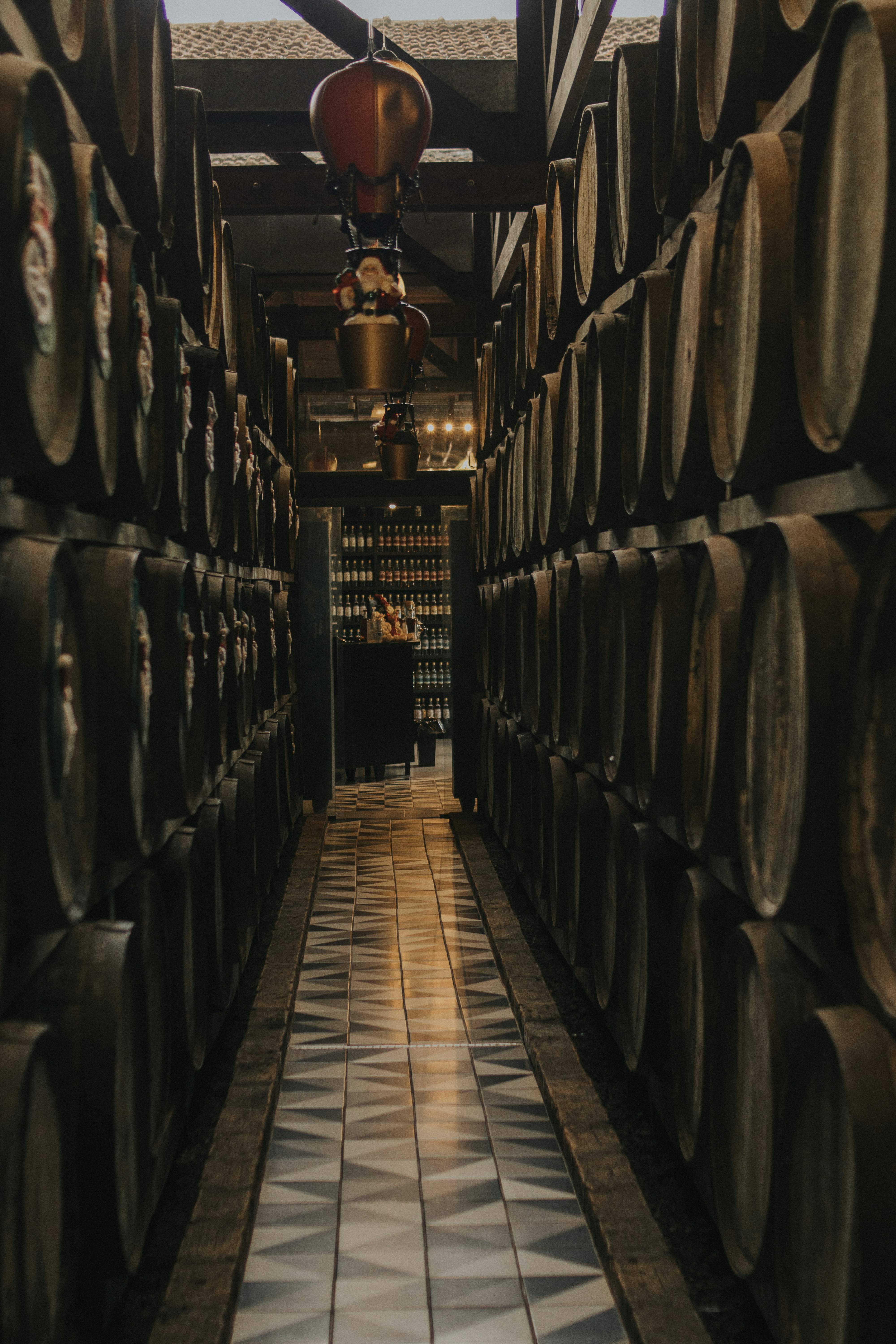 A long row of wine barrels in a wine cellar photo – Free Alcohol Image ...