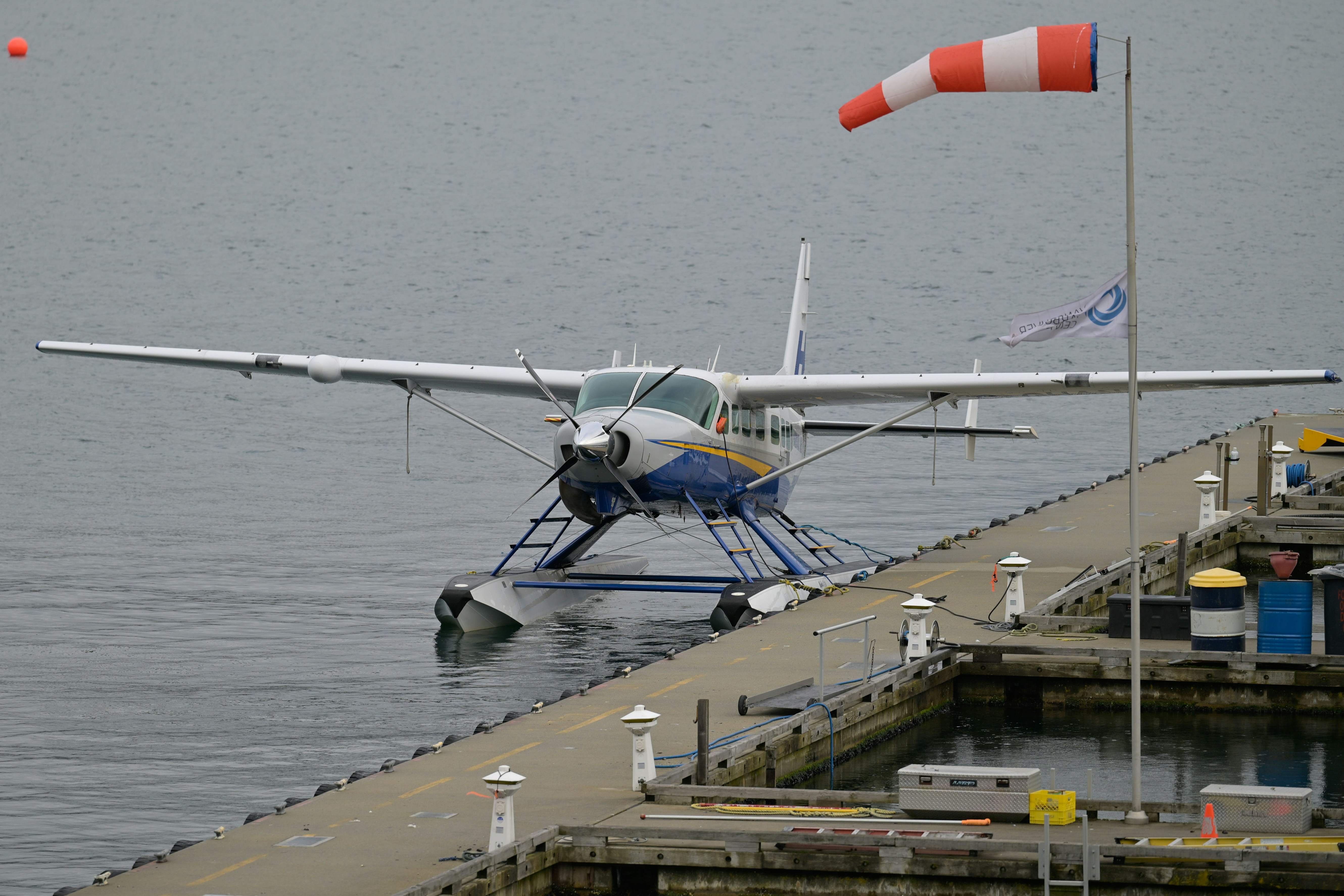 Harbor Tranquility: Striped Windsock Framing a Docked Seaplane